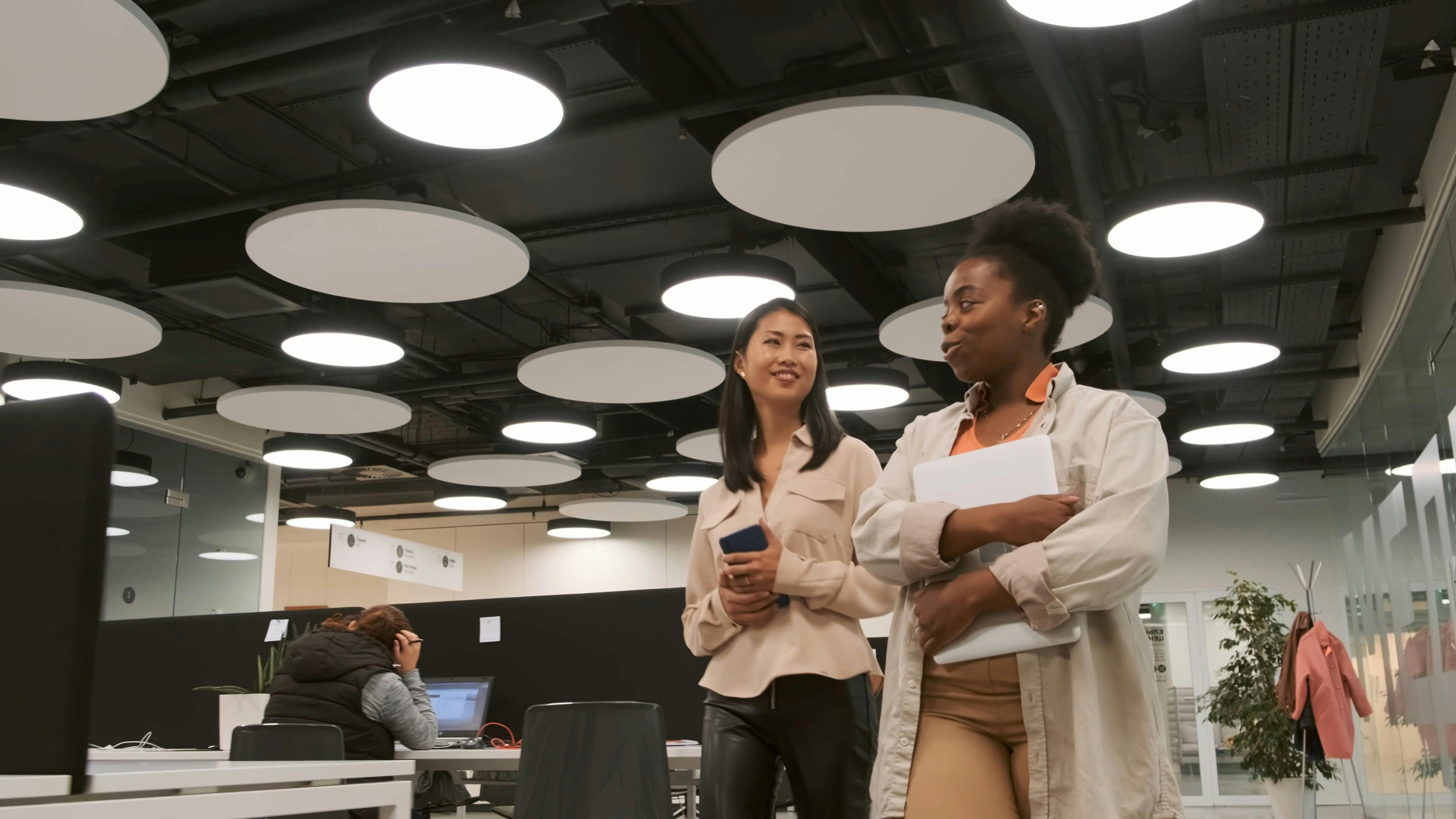 Two Women Talking While Walking In The Office · Free Stock Video
