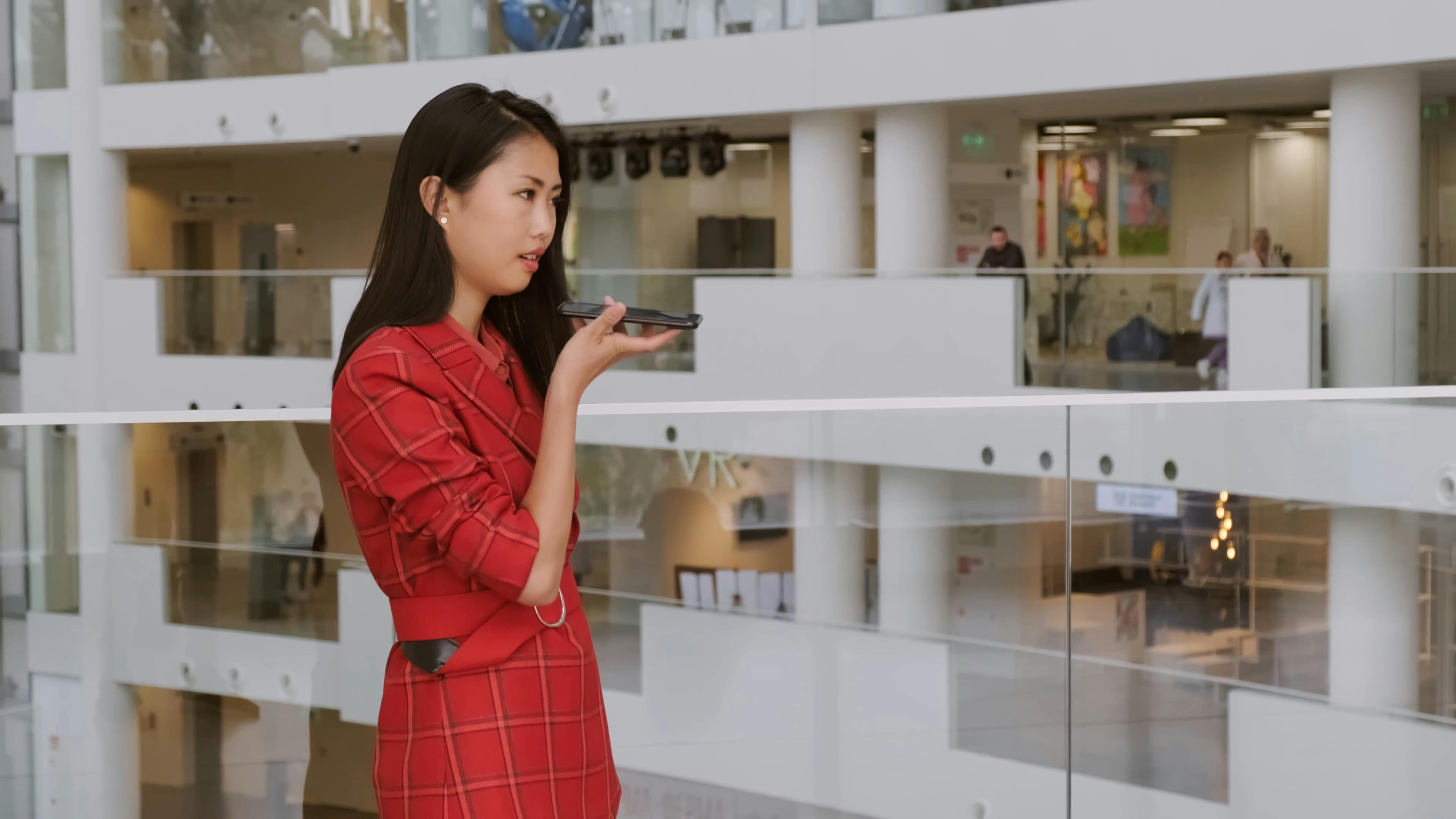 A Woman Talking Through The Speaker Of Her Phone When Approached By ...