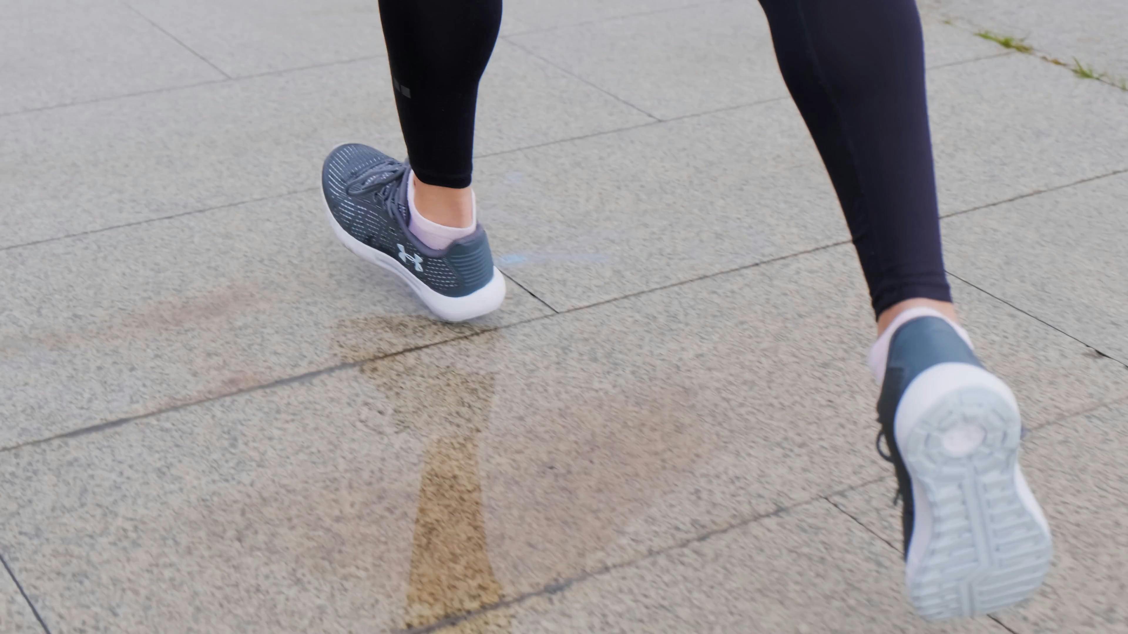 A Person Running On A Wet Concrete Pavement · Free Stock Video