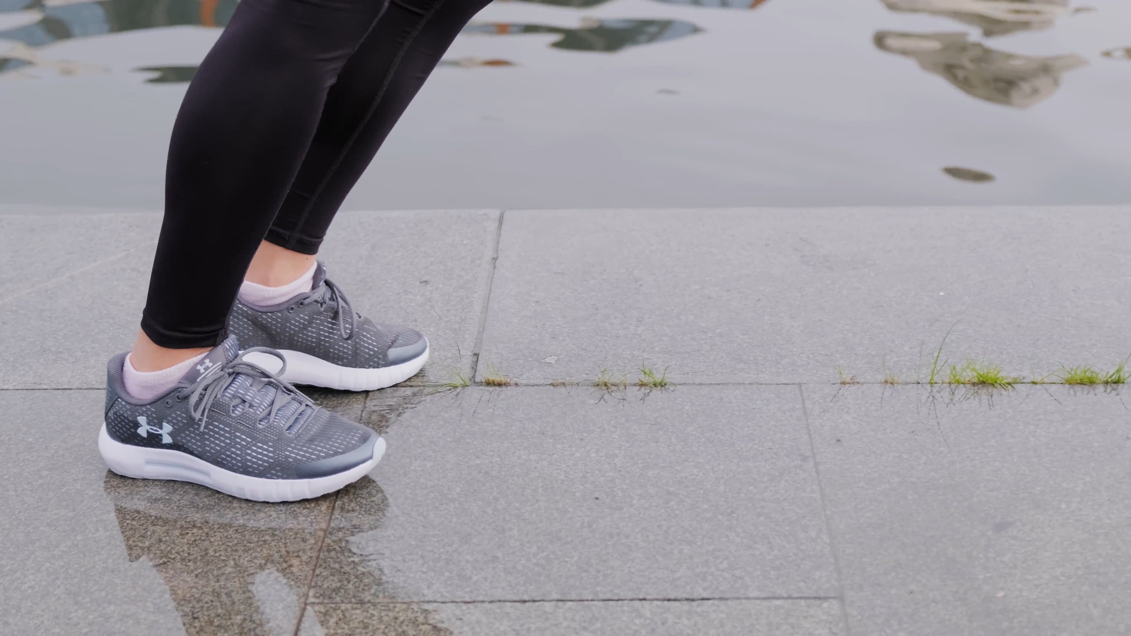 A Person Running On The Pavement Built On The Riverbank · Free Stock Video