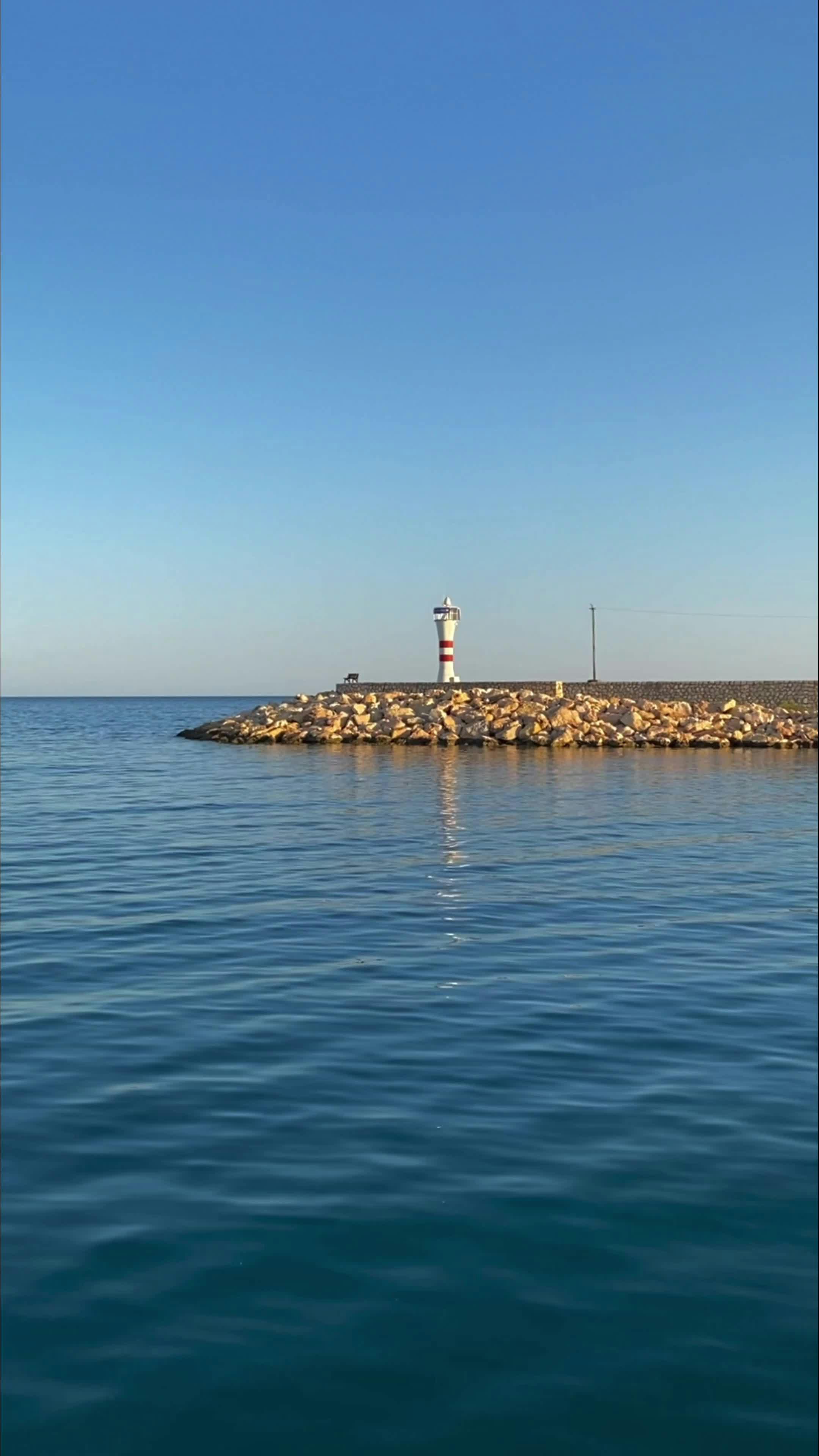 Tranquil Lighthouse on Rocky Seaside in Daylight Free Stock Video ...