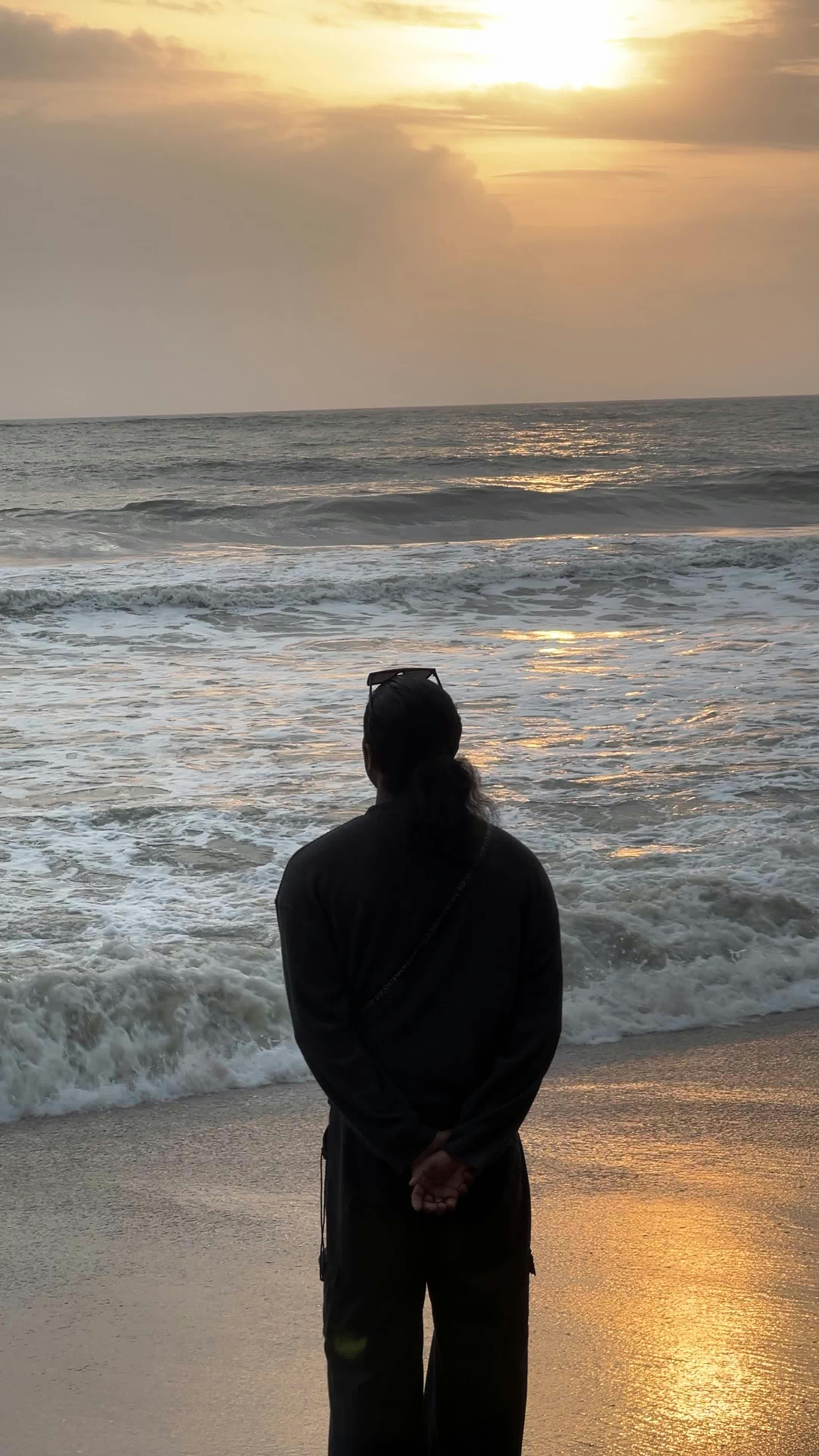 A man standing on the beach watching the sunset Free Stock Video ...