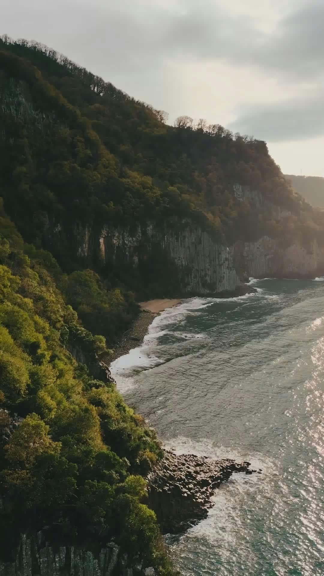 Scenic Coastal Cliffside with Waves and Lush Vegetation Free Stock ...