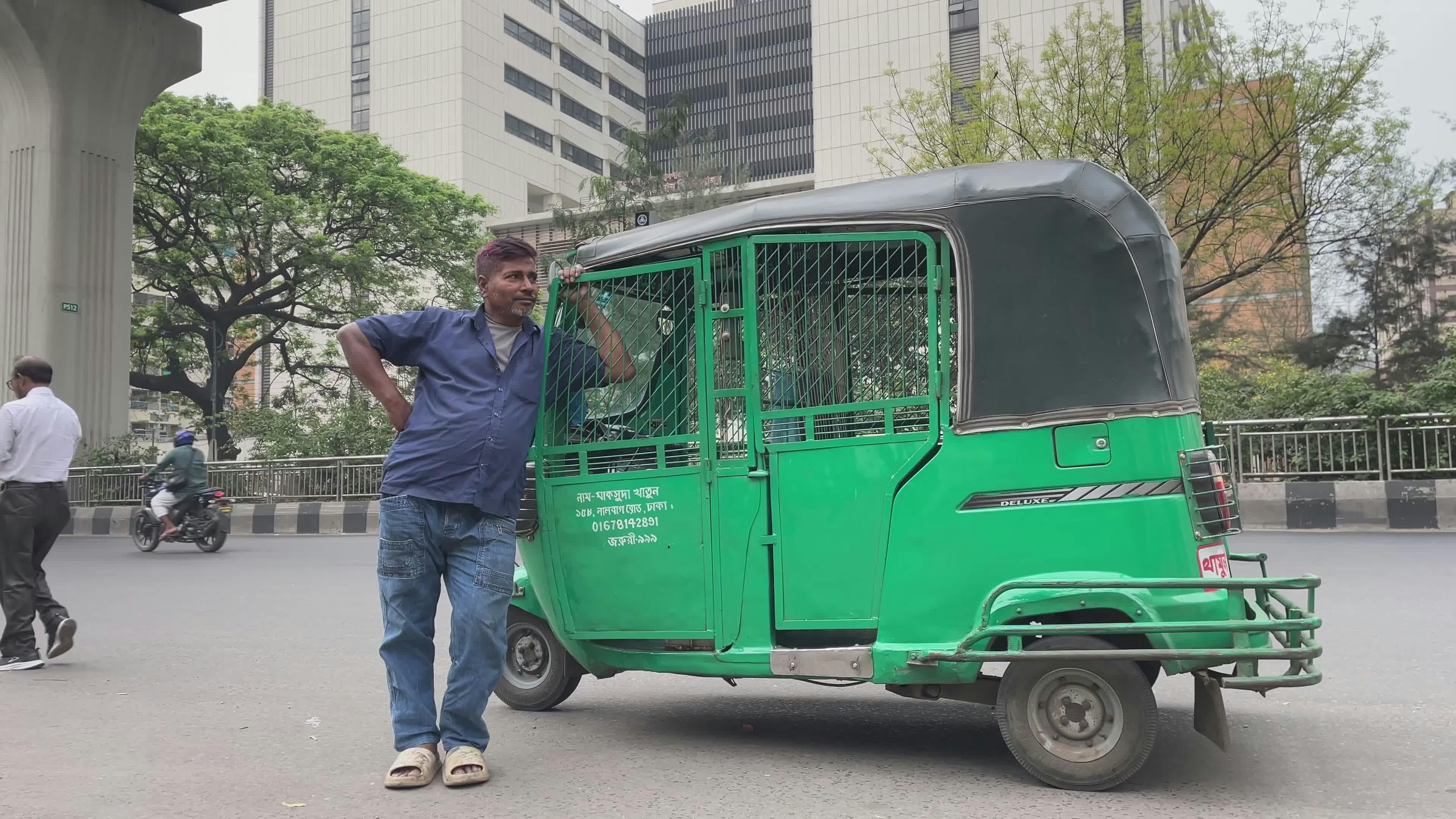 Man Leaning on Green Tuk-Tuk in Urban Setting Free Stock Video Footage ...