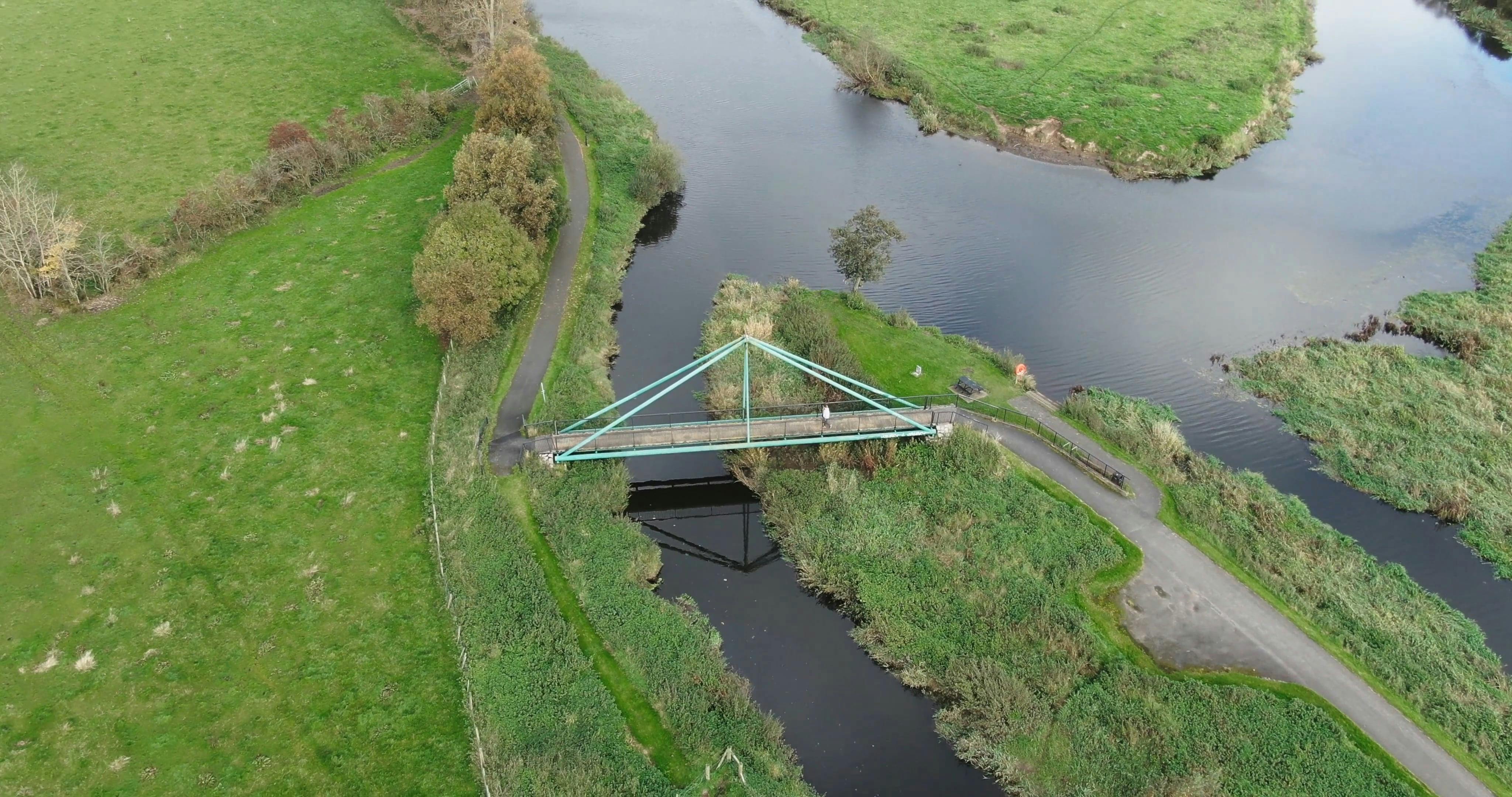 People Crossing A Walk Bridge Built Over The River · Free Stock Video