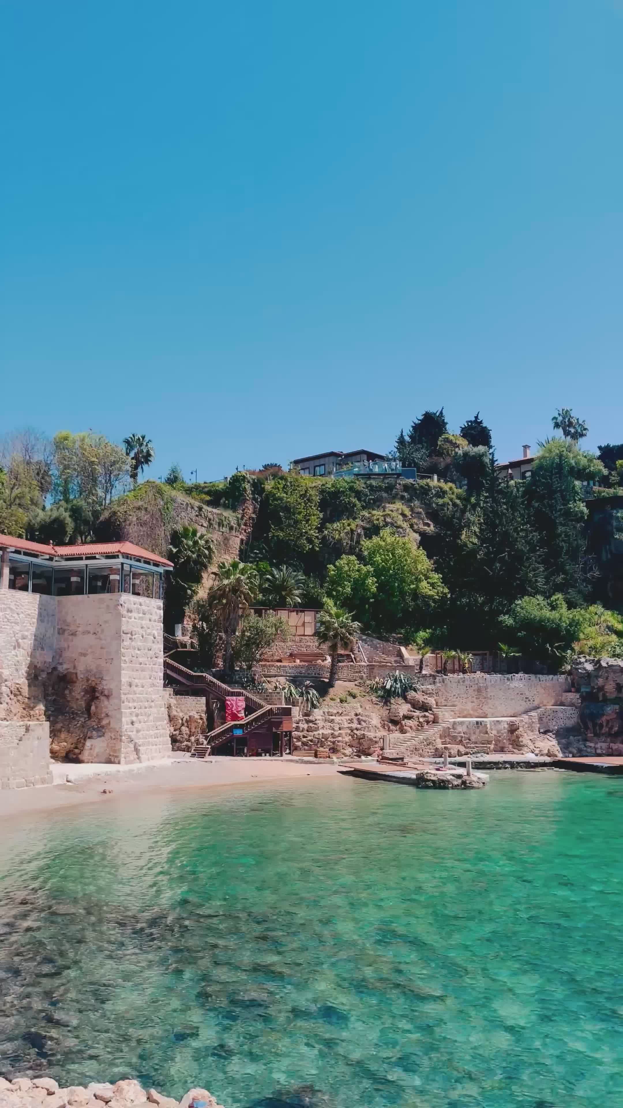 Sunny Seaside View with Historic Stone Structure Free Stock Video ...