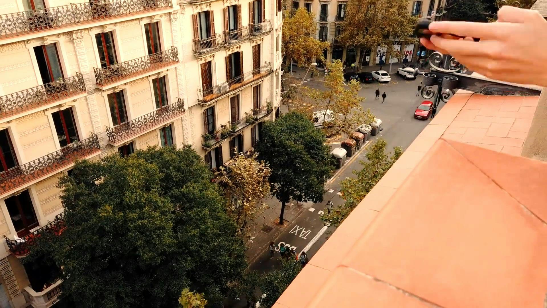 People On Rooftop Overlooking A Busy Street · Free Stock Video