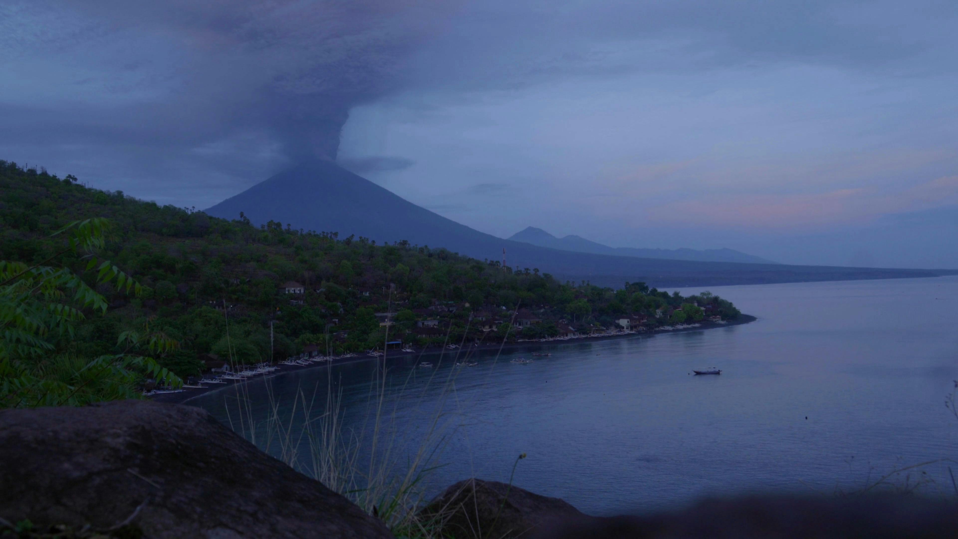 A Man Watches A Volcano Erupting From A Safe Distance · Free Stock Video