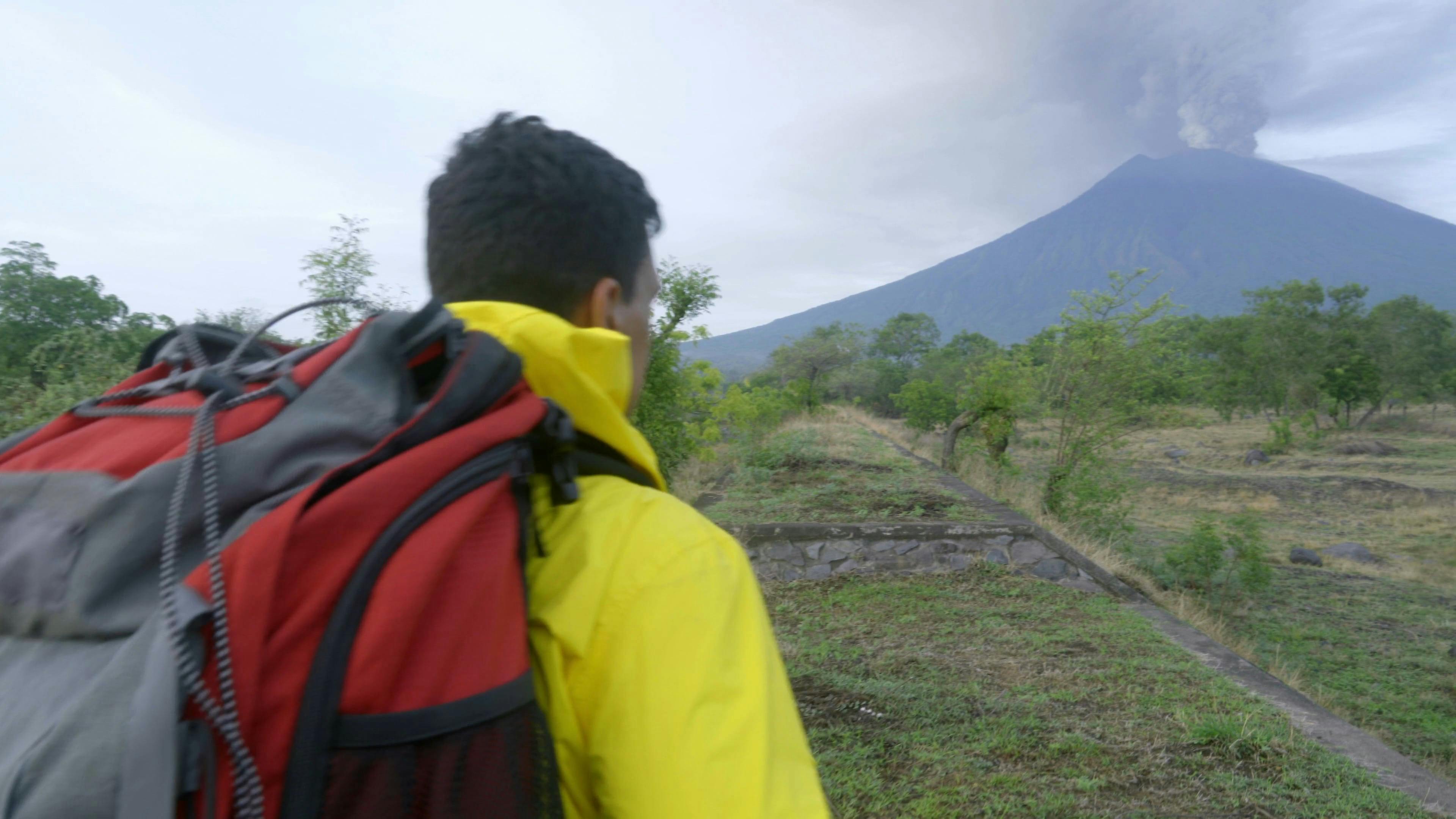 A Man Watches A Volcano Erupting From A Safe Distance Free Stock Video ...