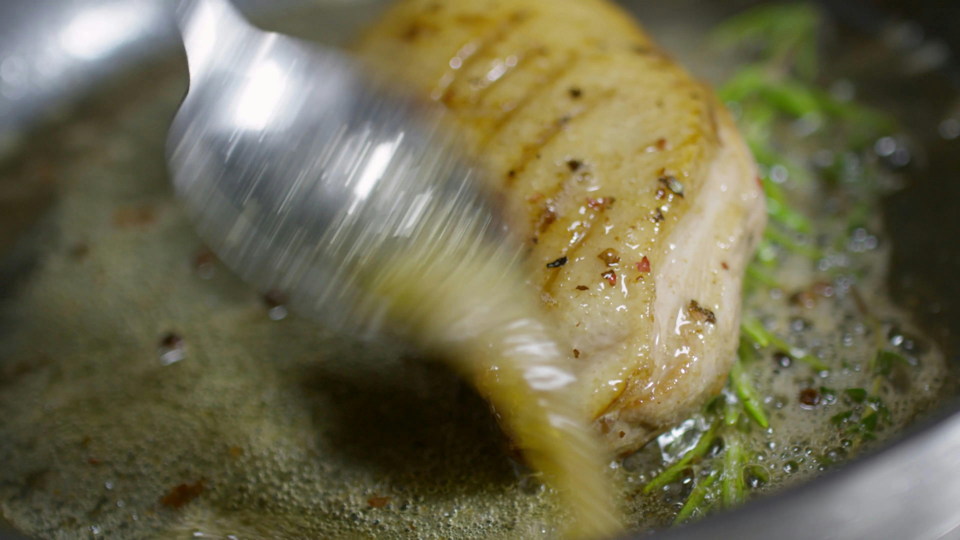 Person Frying A Chicken Fillet · Free Stock Video