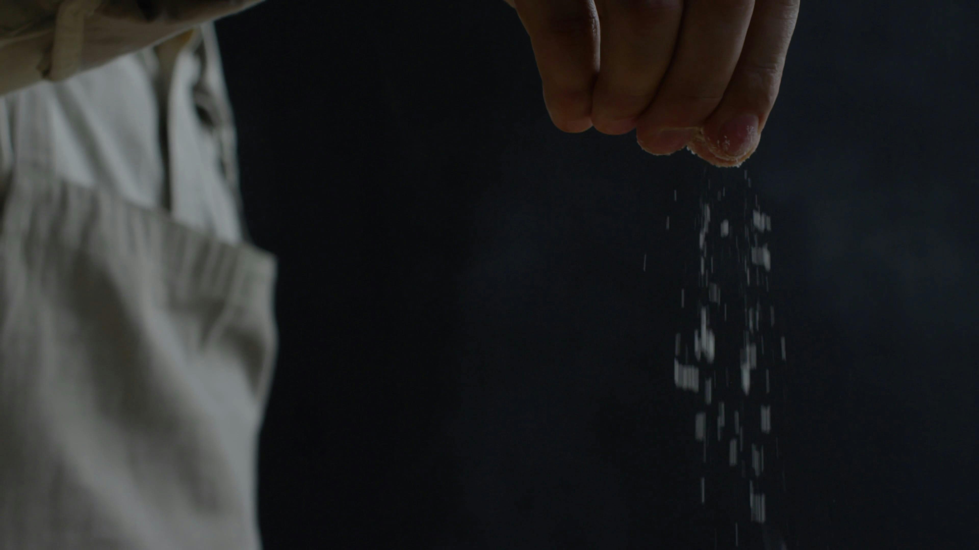 Sprinkling Rock Salt As Seasoning On A Dish Being Cooked Free Stock ...