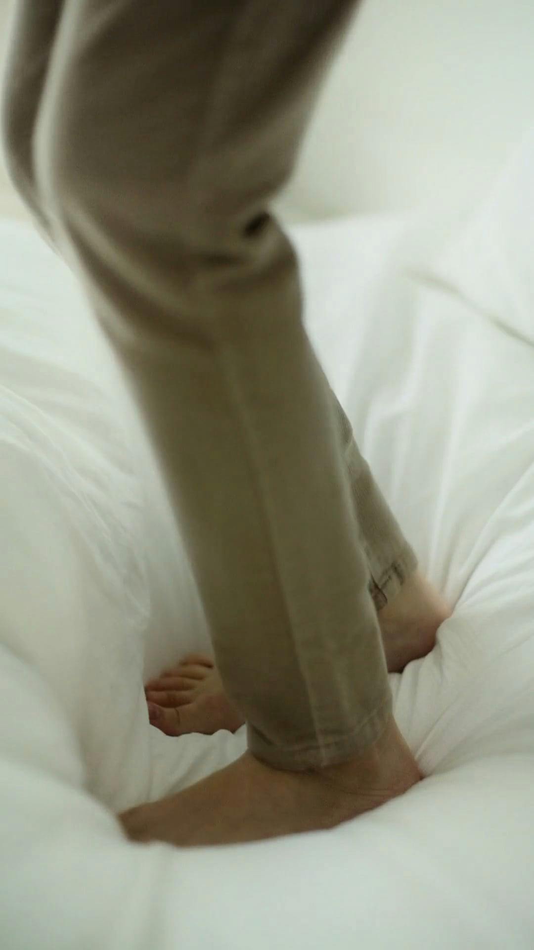 Feet Of A Person Jumping Up And Down On A Bed · Free Stock Video