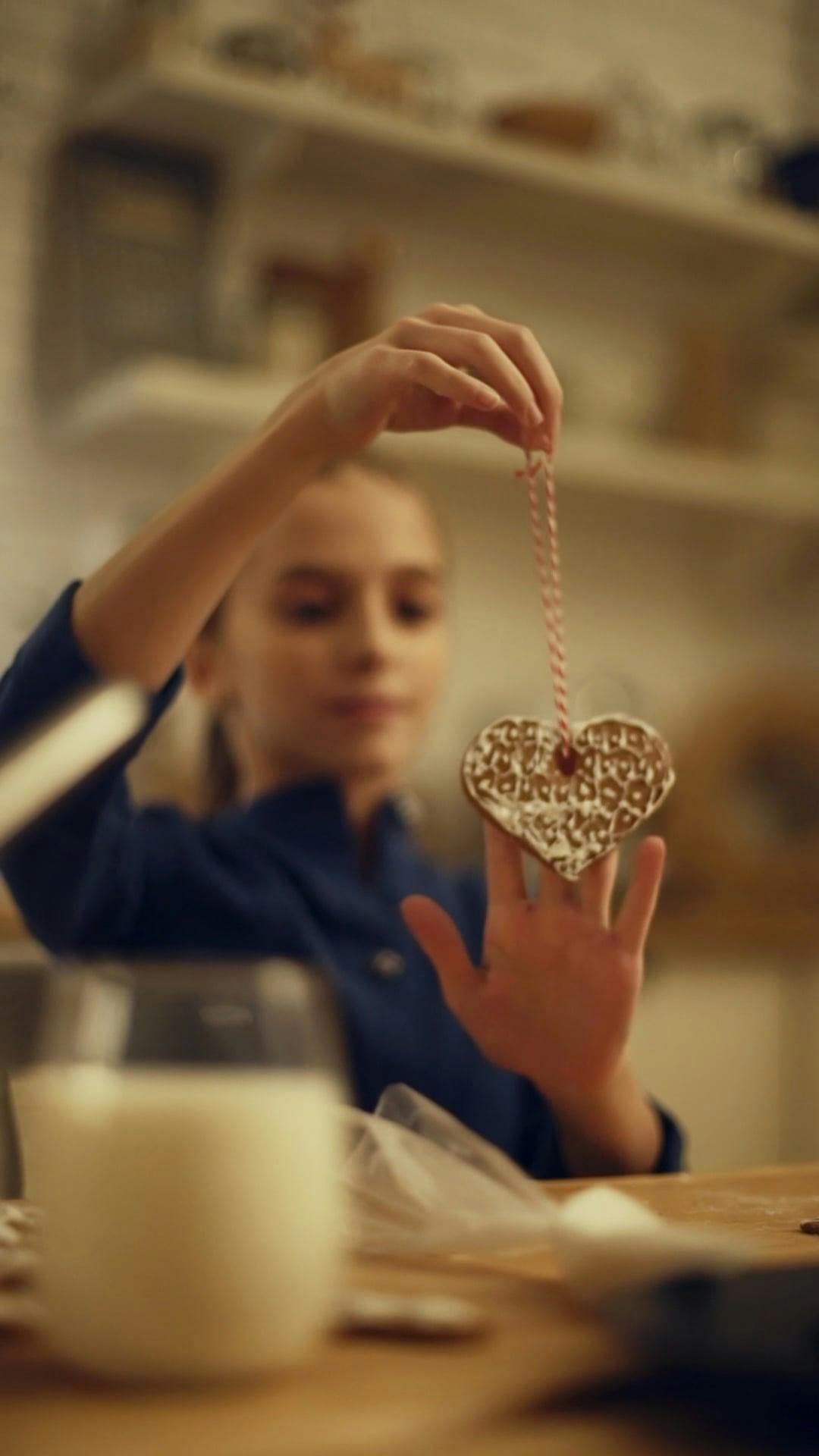 A Girl Putting A String On A Cookie To Hang · Free Stock Video