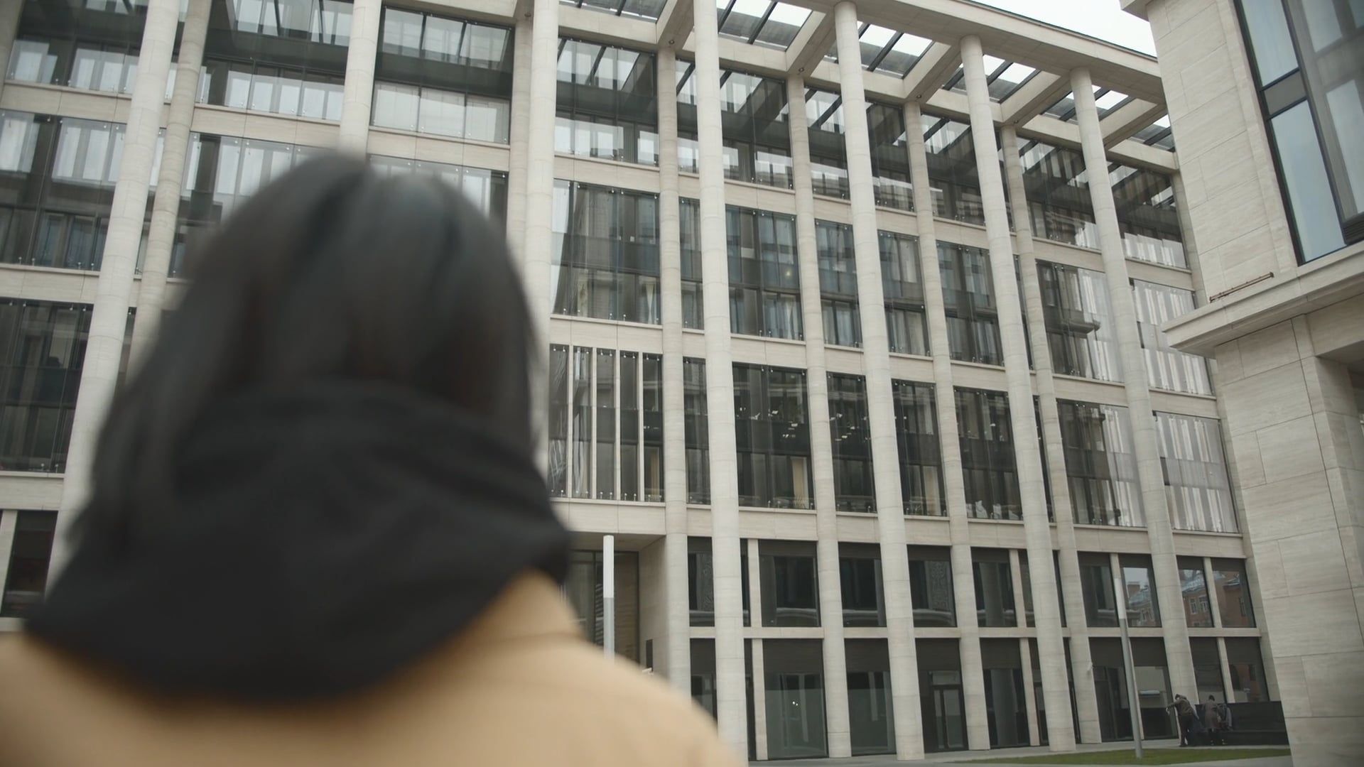 Man Sitting Outside A Building Looking At His Phone While Waiting ...