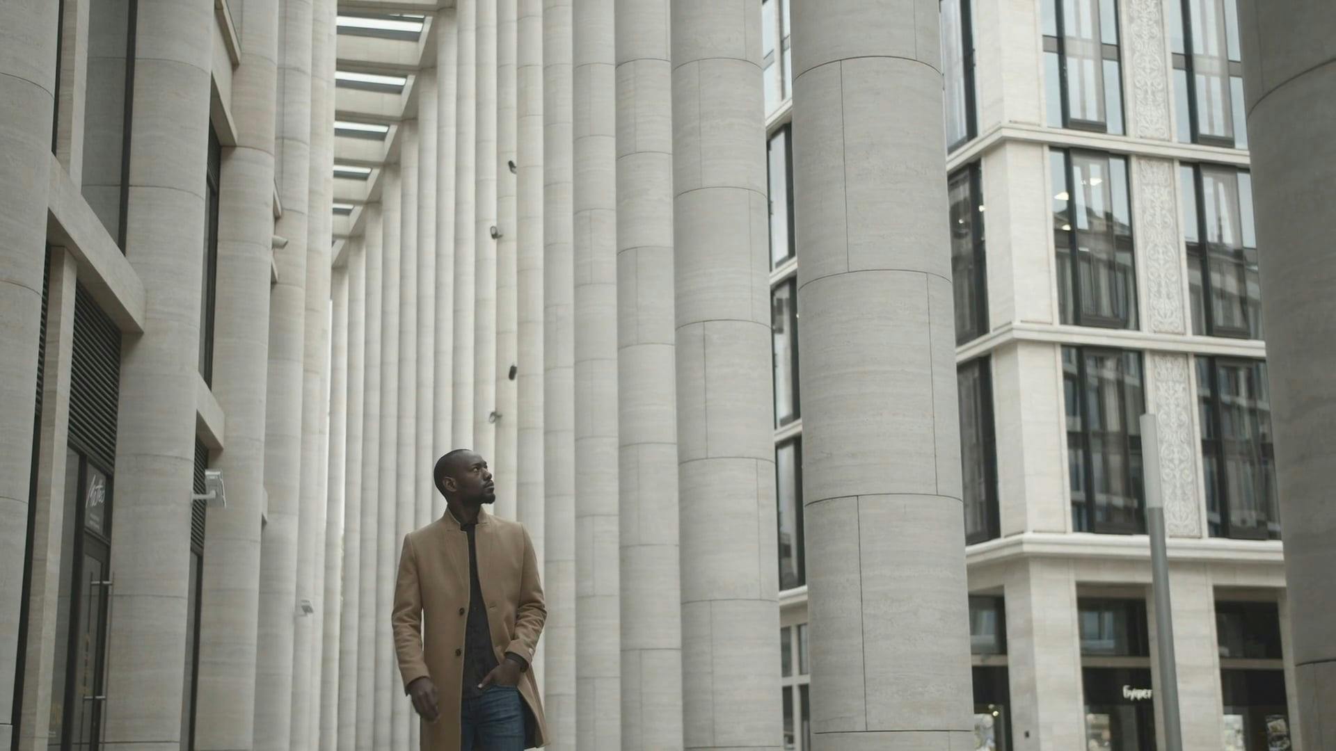 Man Looking Around While Walking Outside A Building · Free Stock Video
