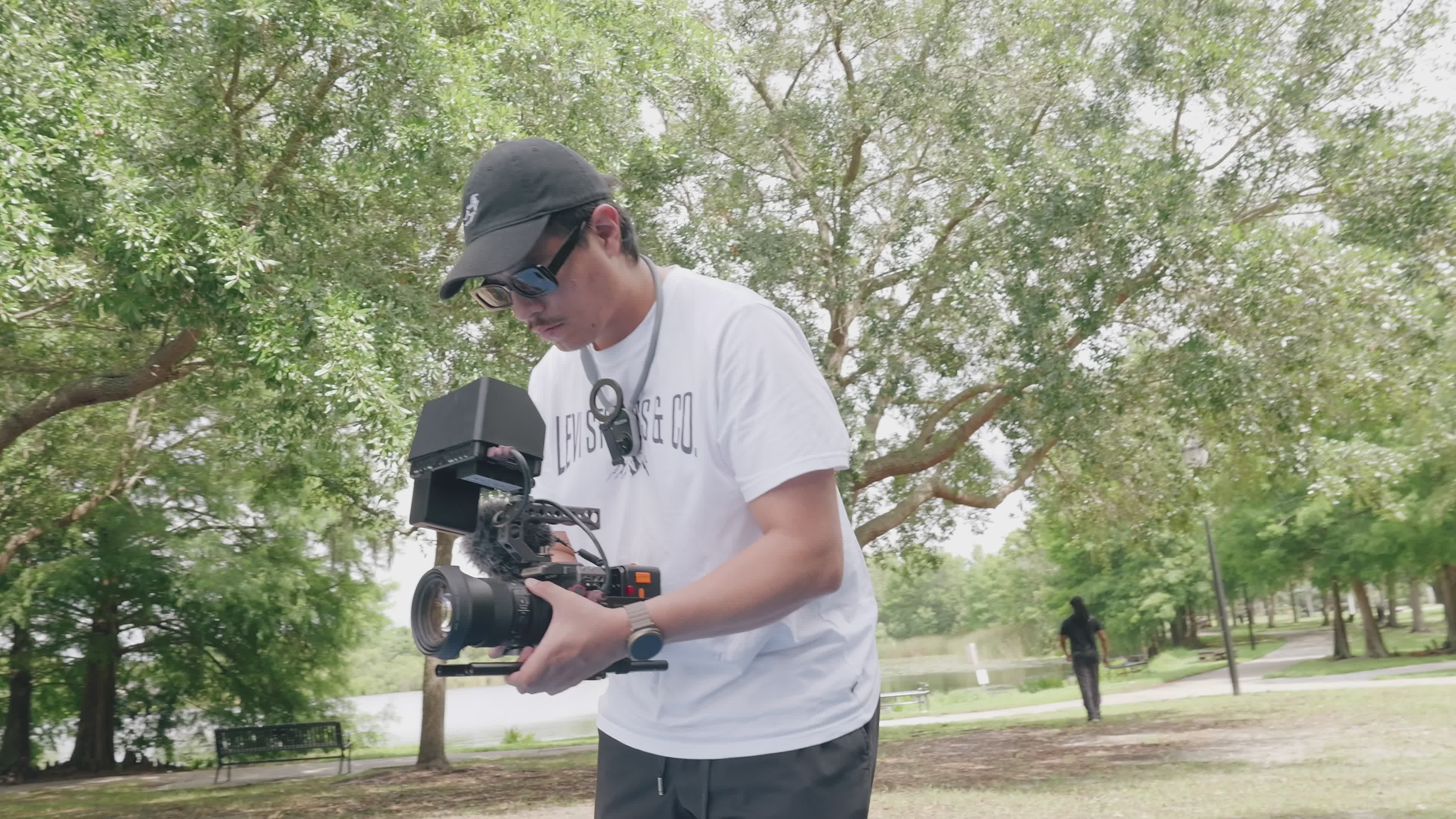 Videographer Filming in Scenic Outdoor Park Free Stock Video Footage ...