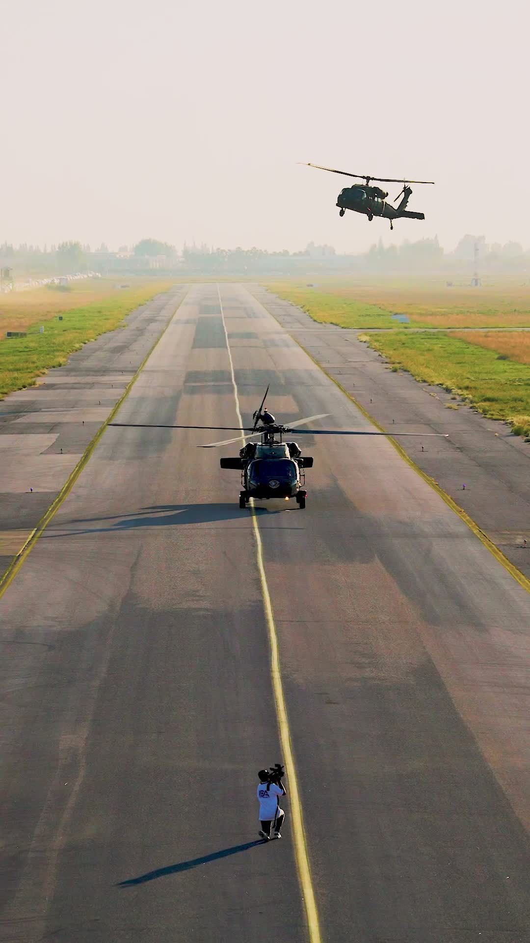 Helicopters Flying Over Runway with Person Below Free Stock Video ...