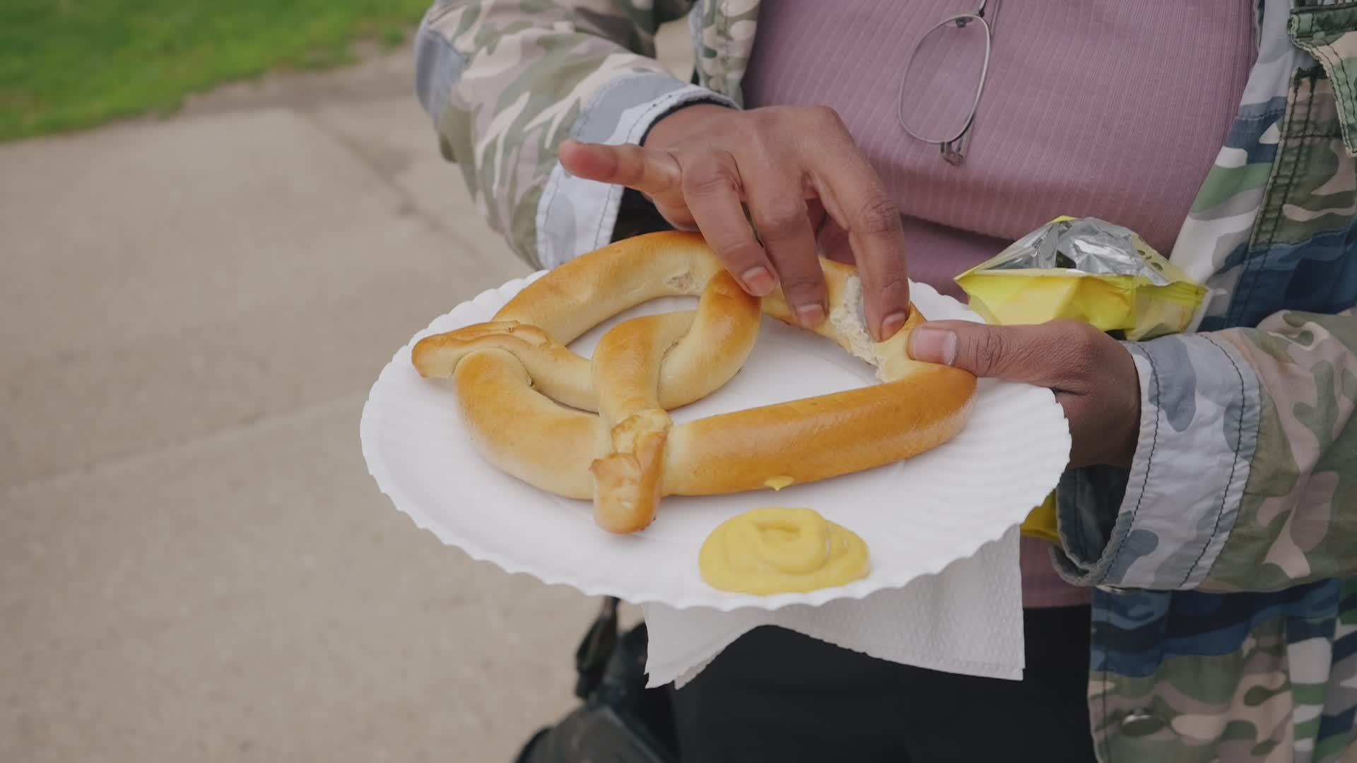 Outdoor Snack: Eating Soft Pretzel with Mustard Free Stock Video ...
