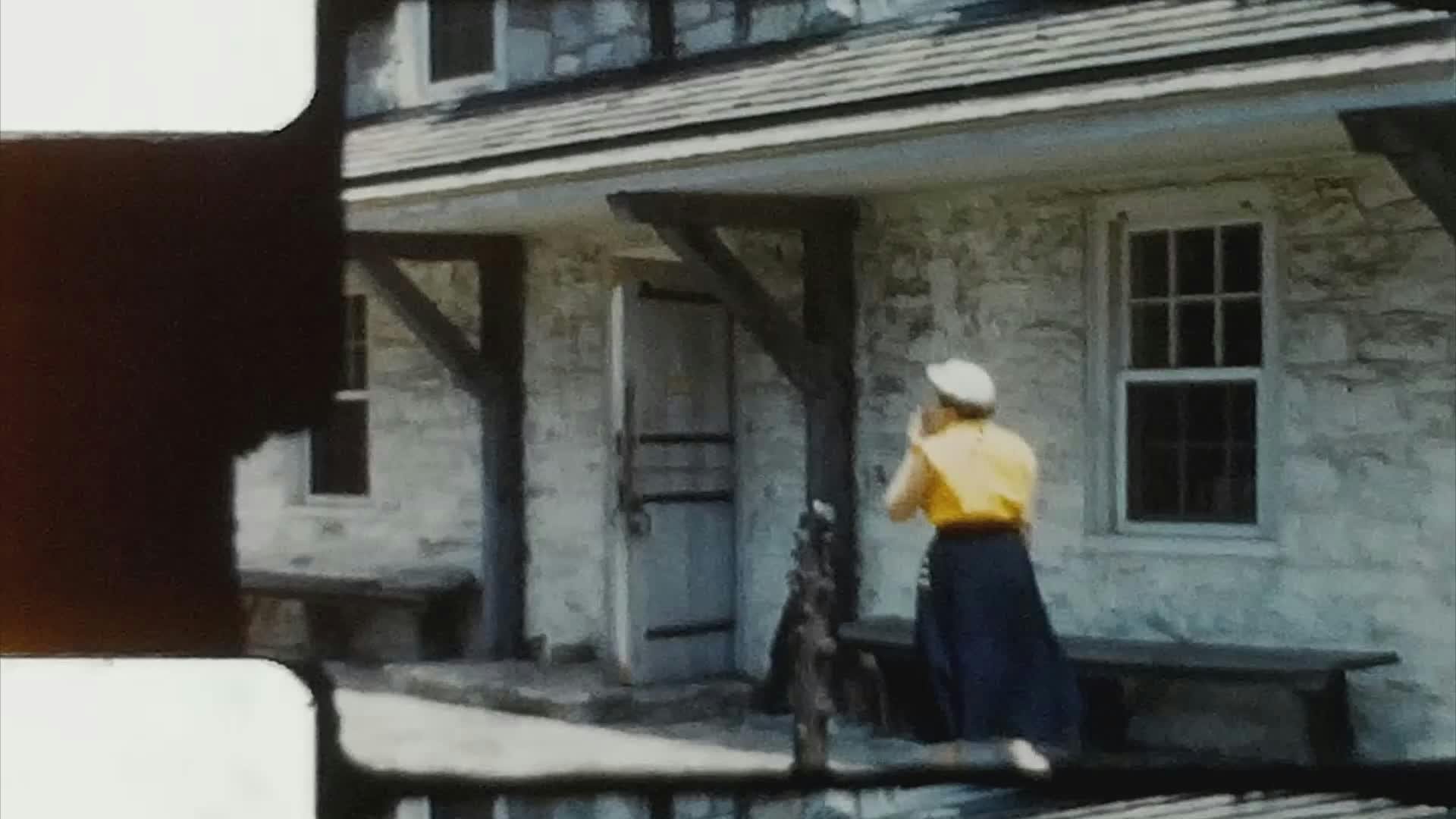 Vintage Woman in Yellow Walking by Stone House Free Stock Video Footage ...