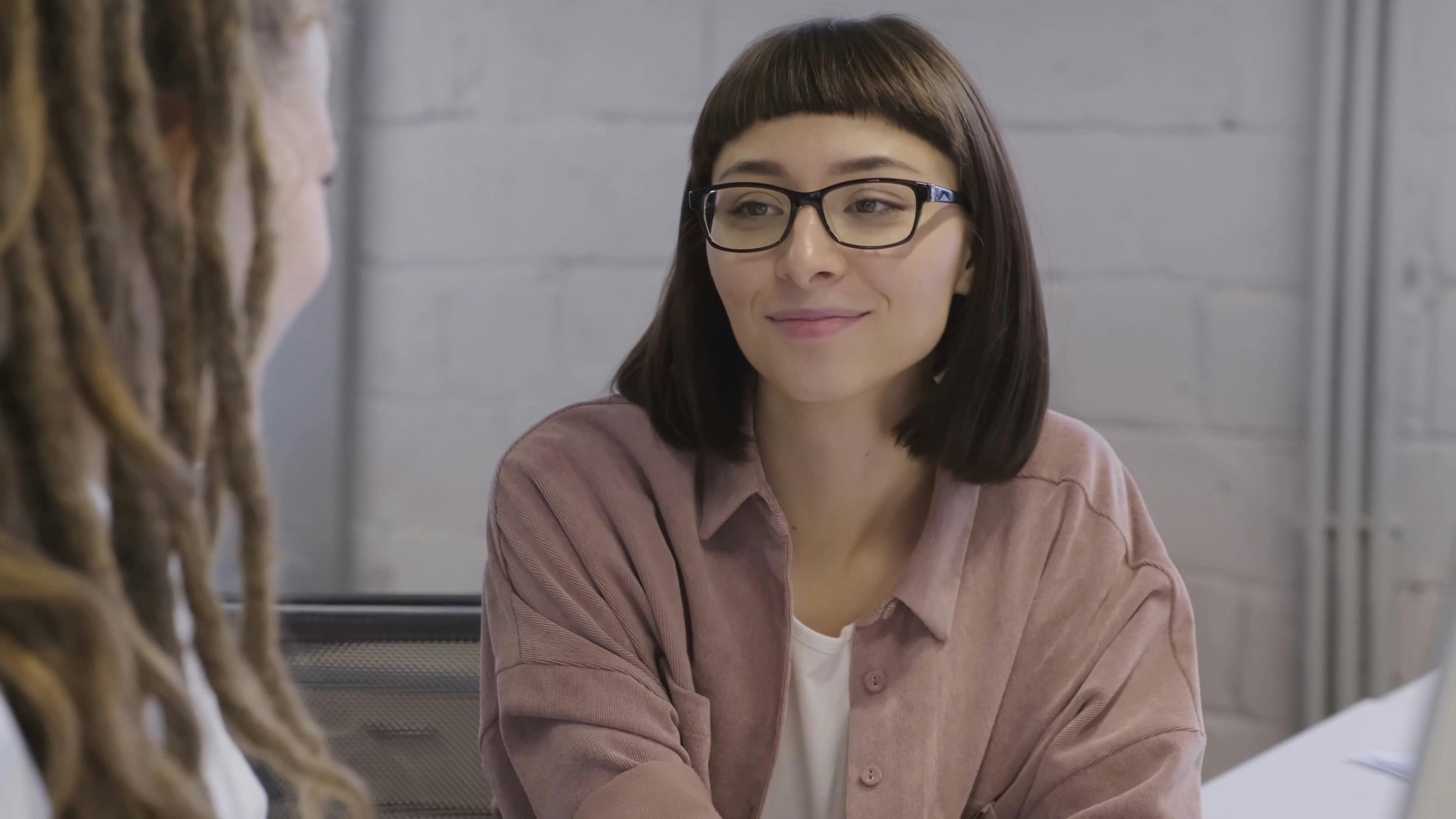 Two Women Smiling And Nodding While Having A Conversation With Each ...