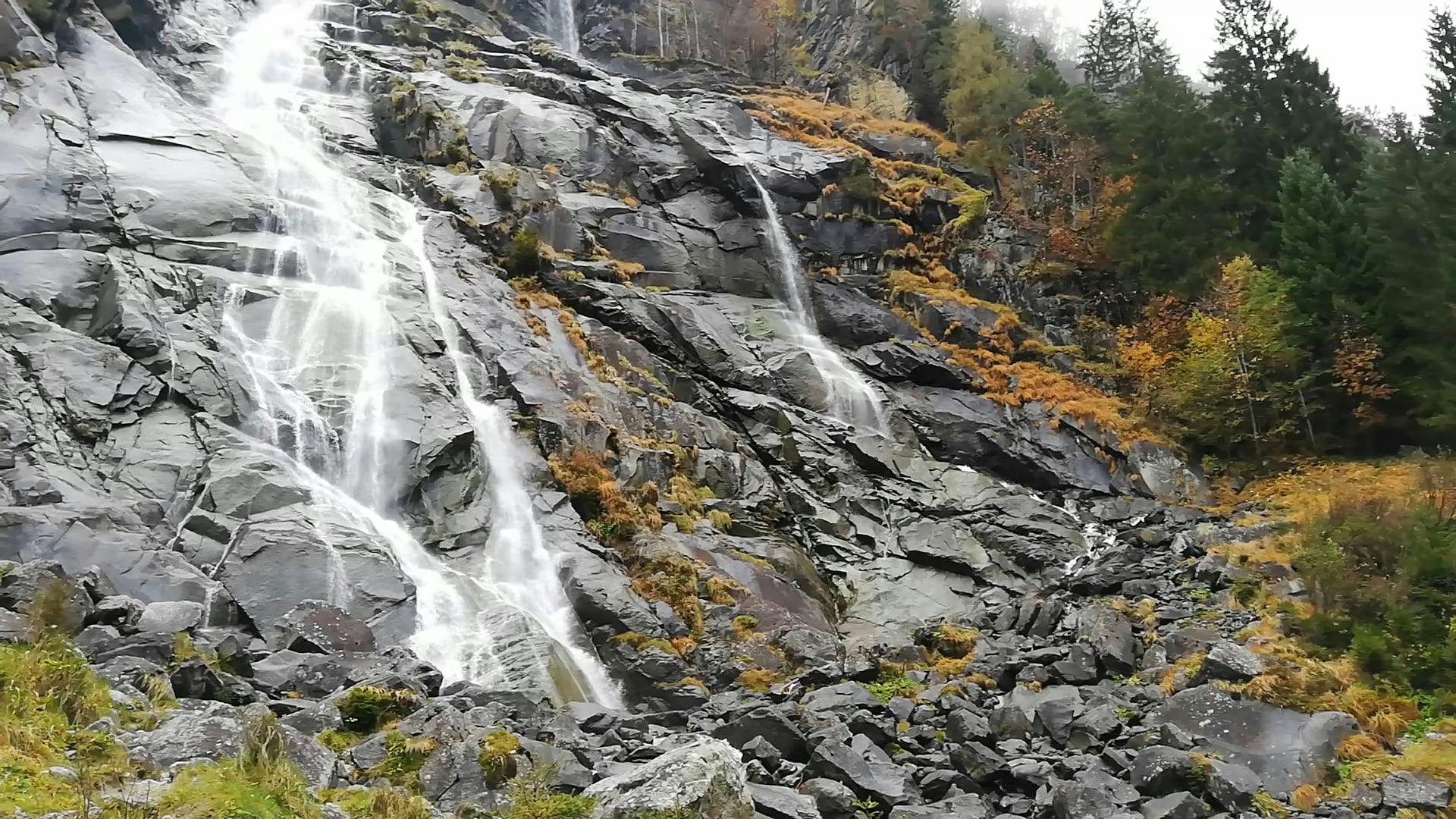 A Waterfalls Cascading Down Through The Sides Of A Mountain Rock · Free ...