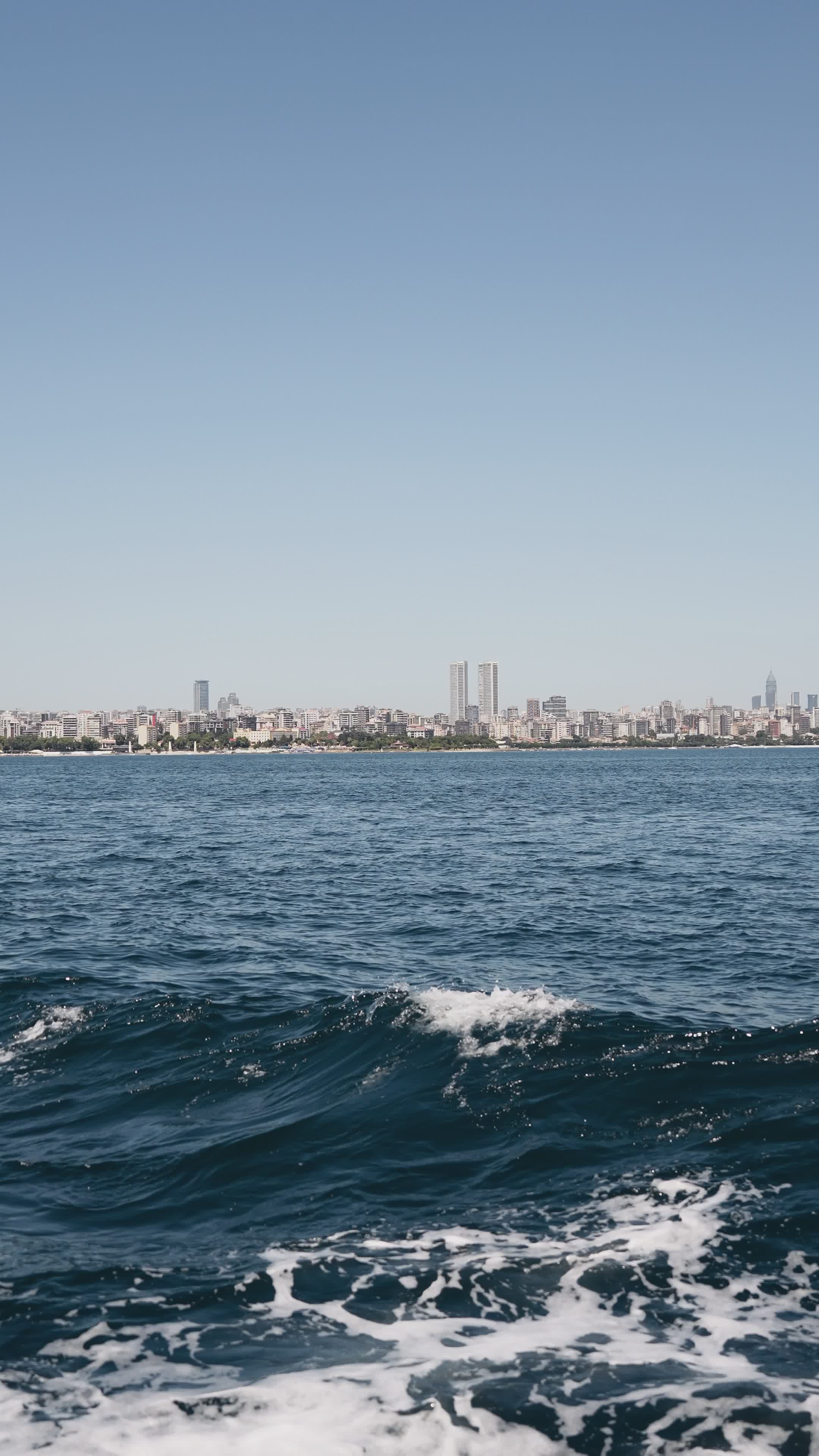 Vibrant Ocean Waves with City Skyline View Free Stock Video Footage ...