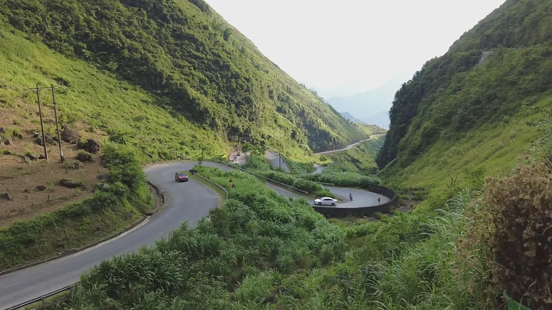 Scenic Mountain Road with Traffic in Lush Valley Free Stock Video ...