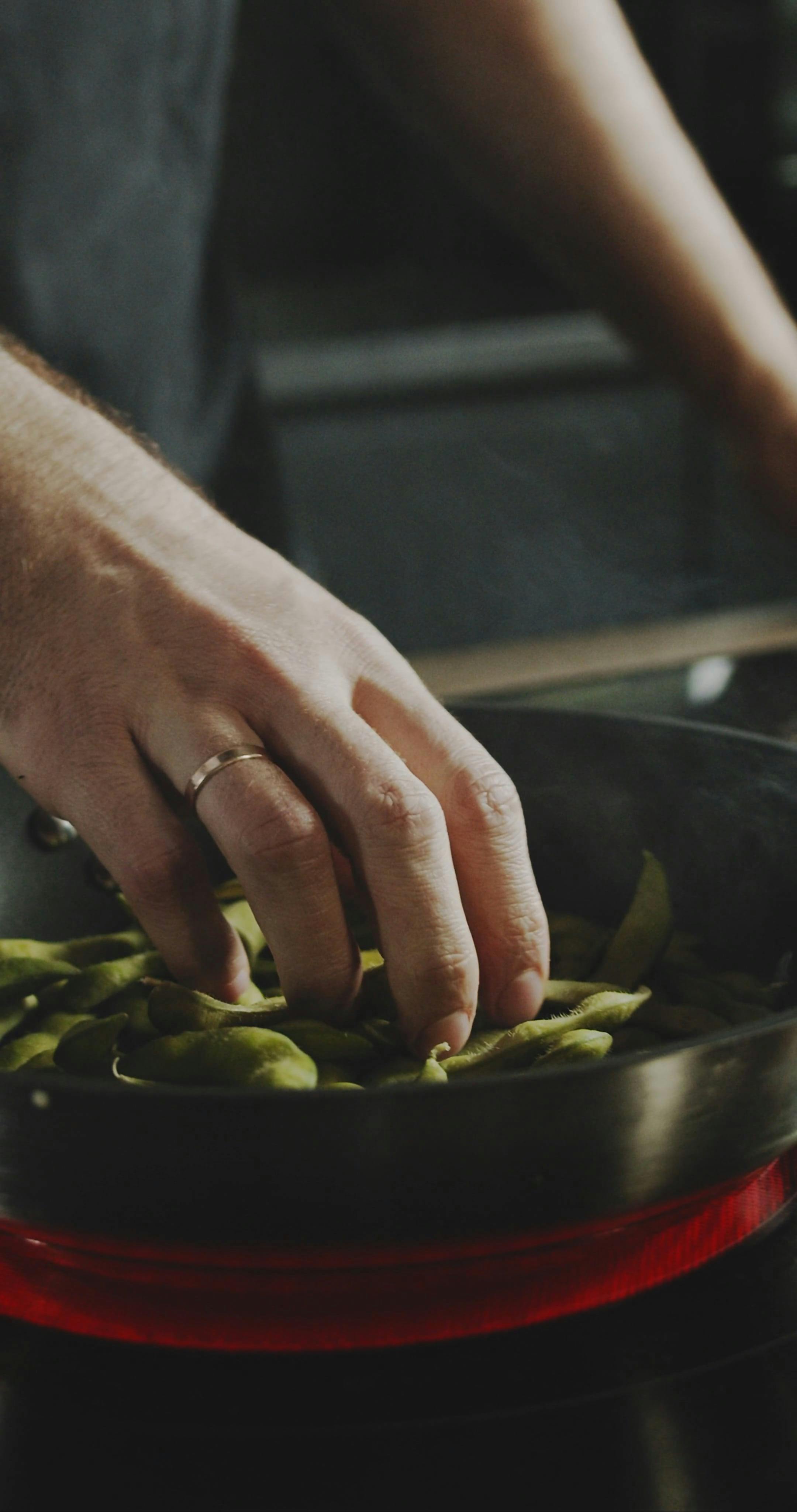 The Chef Touching The Soybean Pod In A Hot Pan · Free Stock Video