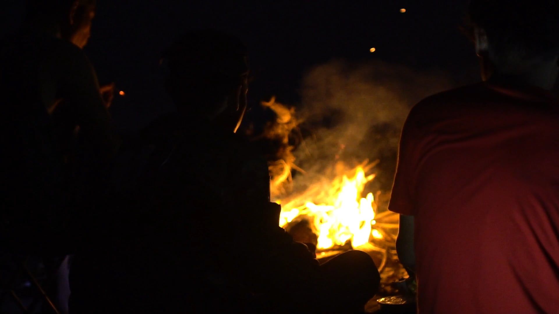 Men Seated Around A Bonfire For Heat And Light In A Dark Night Free ...