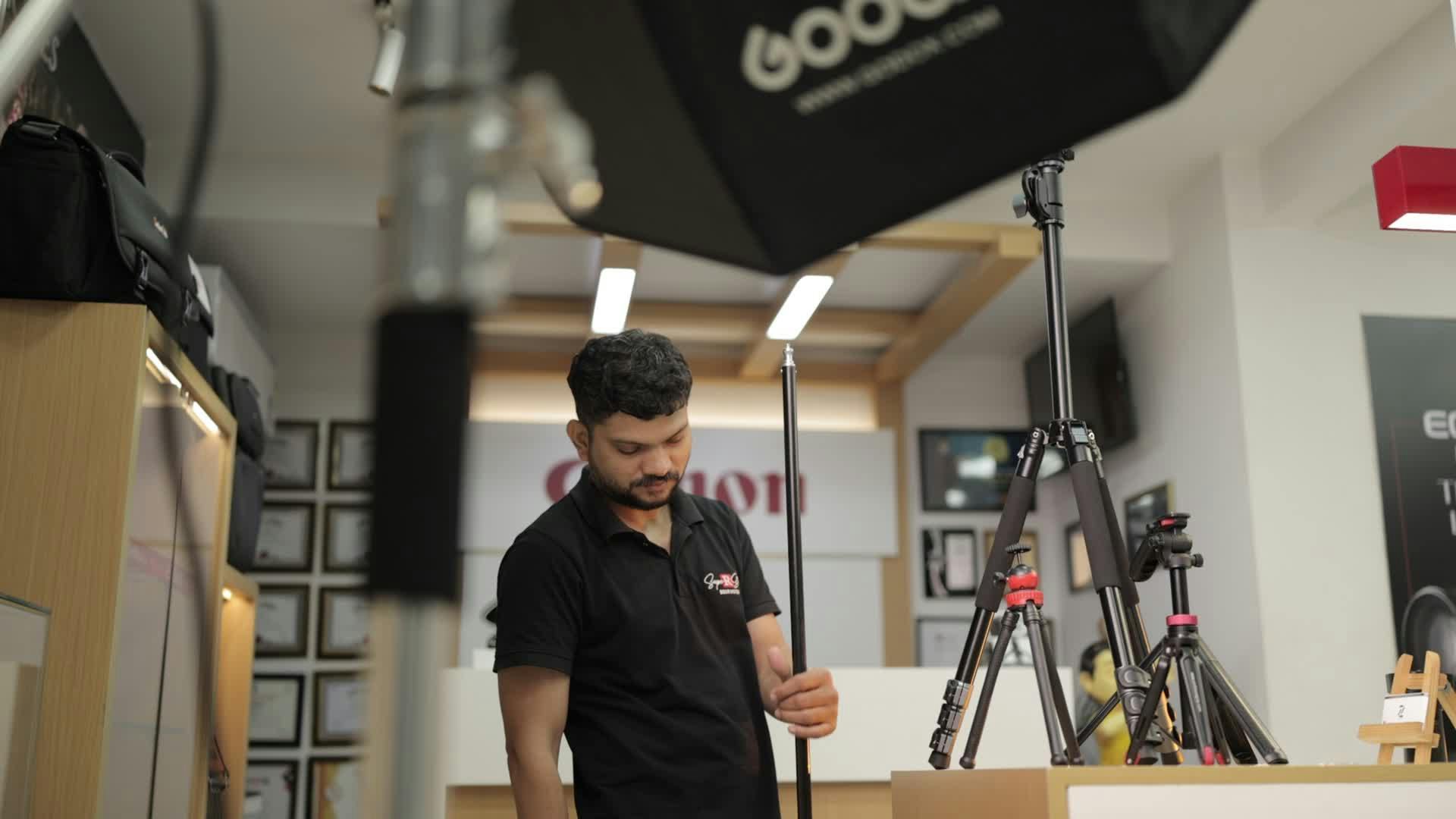 Videographer Preparing Studio with Lighting Equipment Free Stock Video ...