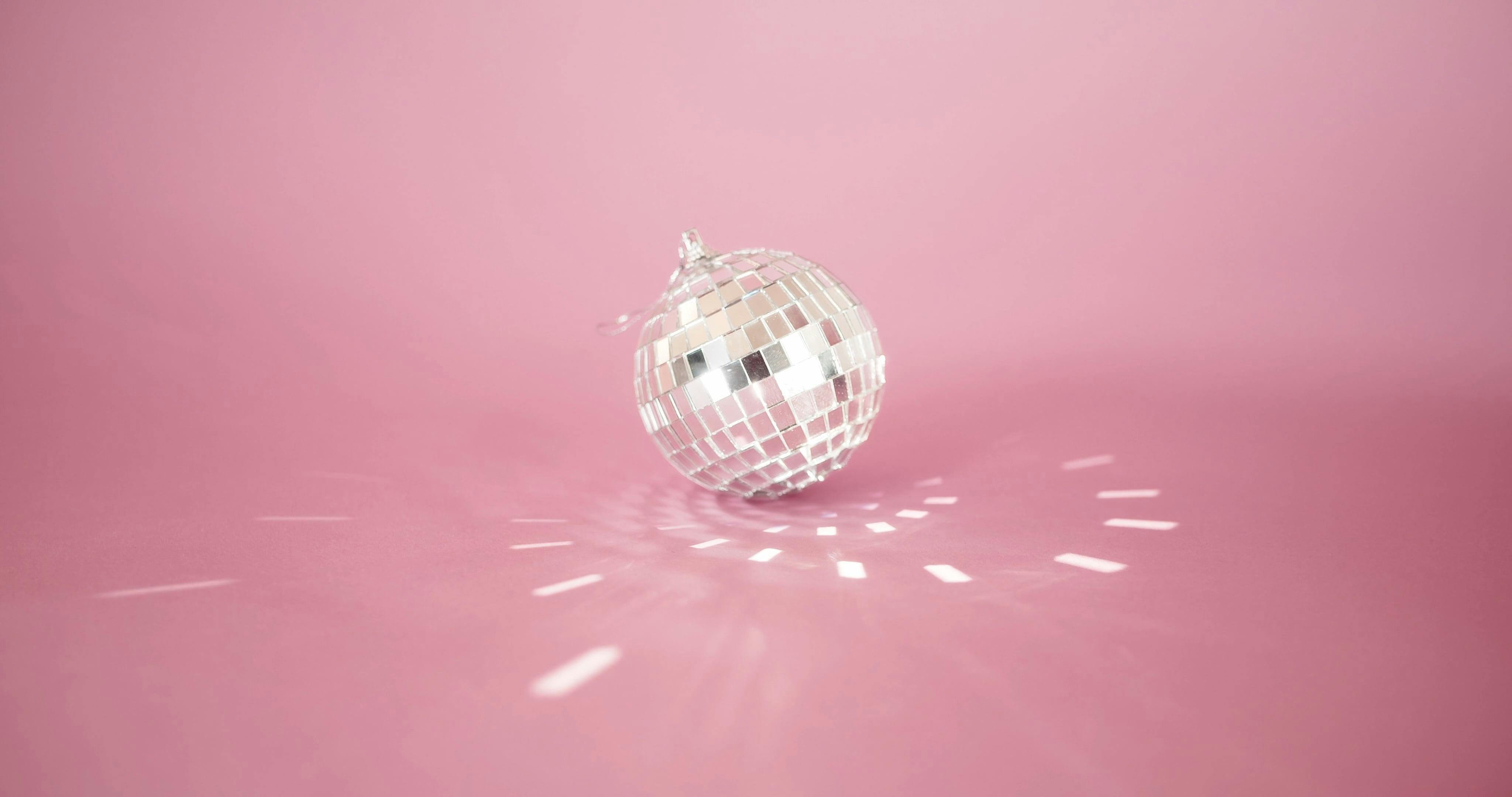 A Small Mirror Ball Bouncing Off Squared Light Reflections In The Pink ...