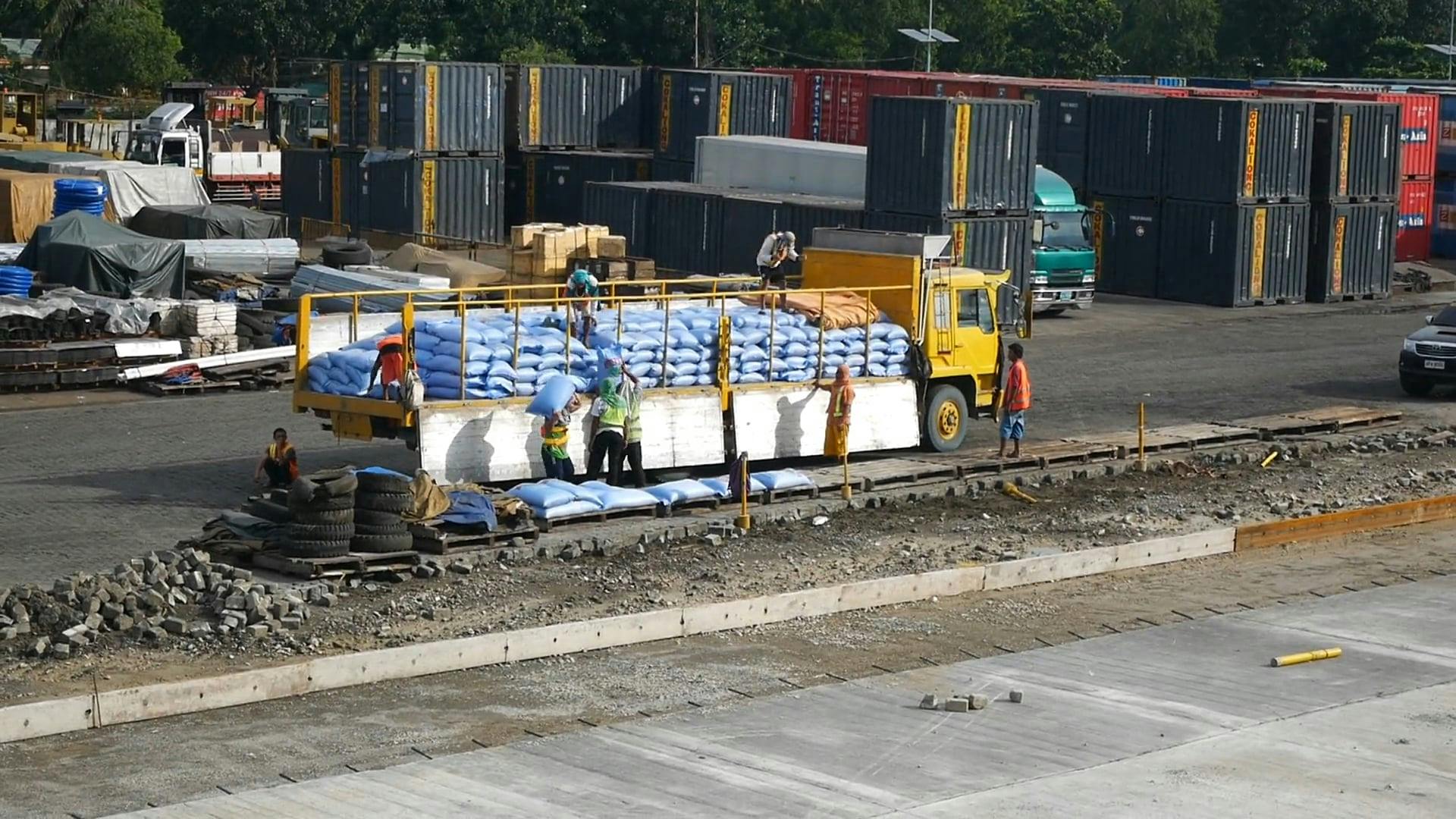 A Group Of Men Unloading Sacks Of Rice From A Cargo Truck · Free Stock ...