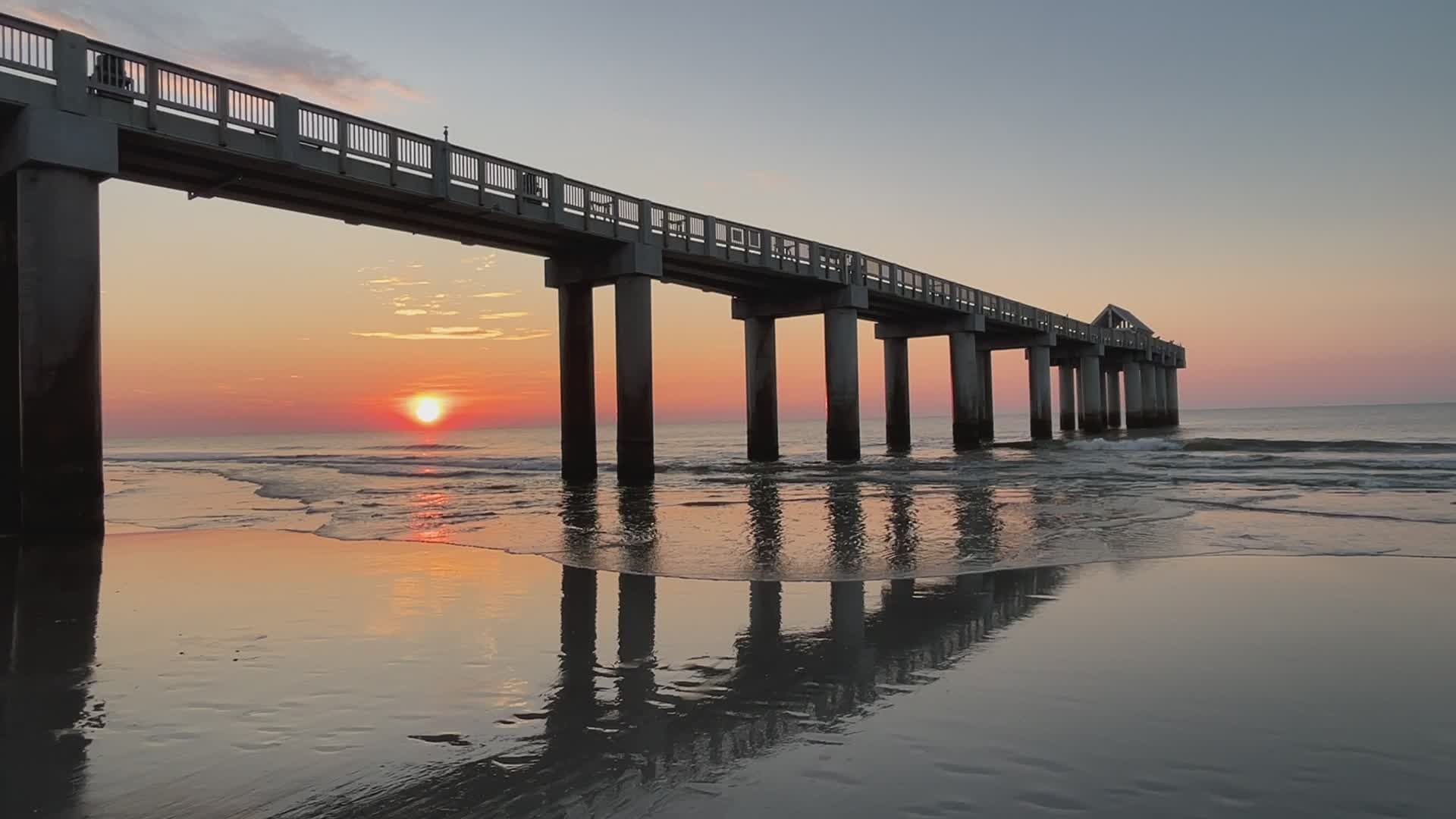 Sunset at Pier with Reflective Ocean Waves Free Stock Video Footage ...