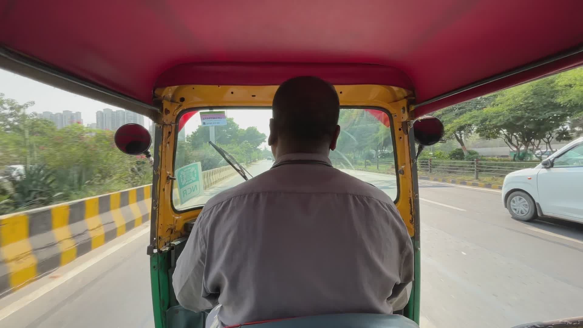 Wide angle shot of an auto rikshaw driver on roads of Delhi India Free ...