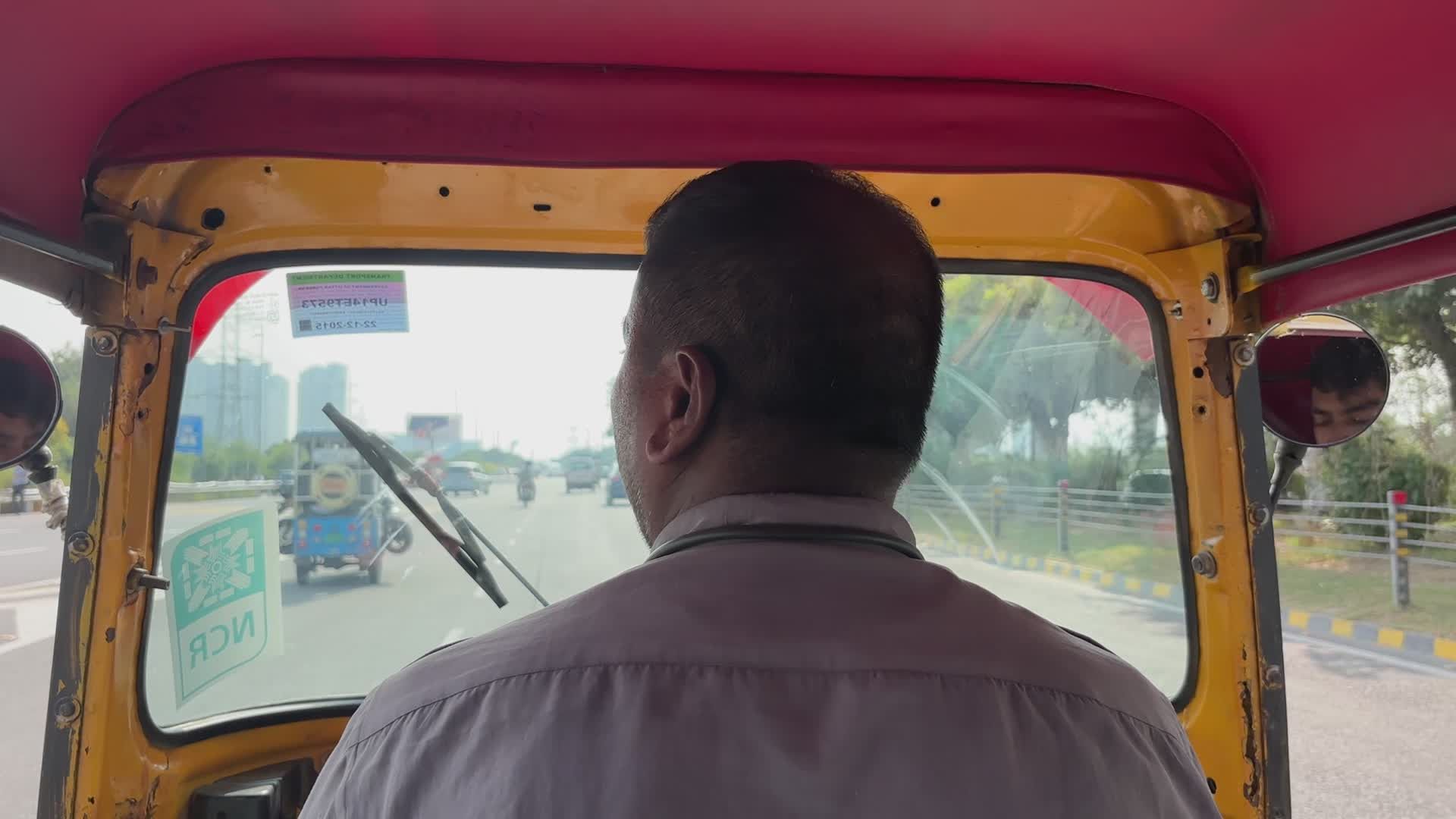 Wide angle shot of an auto rikshaw driver on roads of Delhi India Free ...