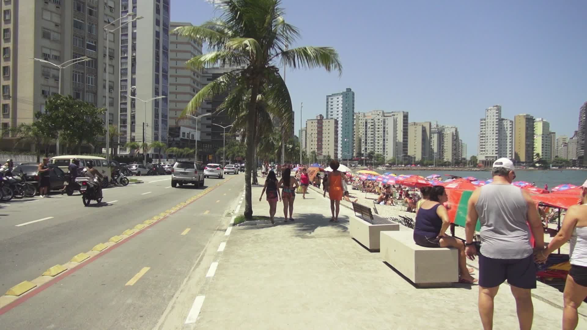 Sunny Beachfront Promenade with Tourists and City View Free Stock Video ...