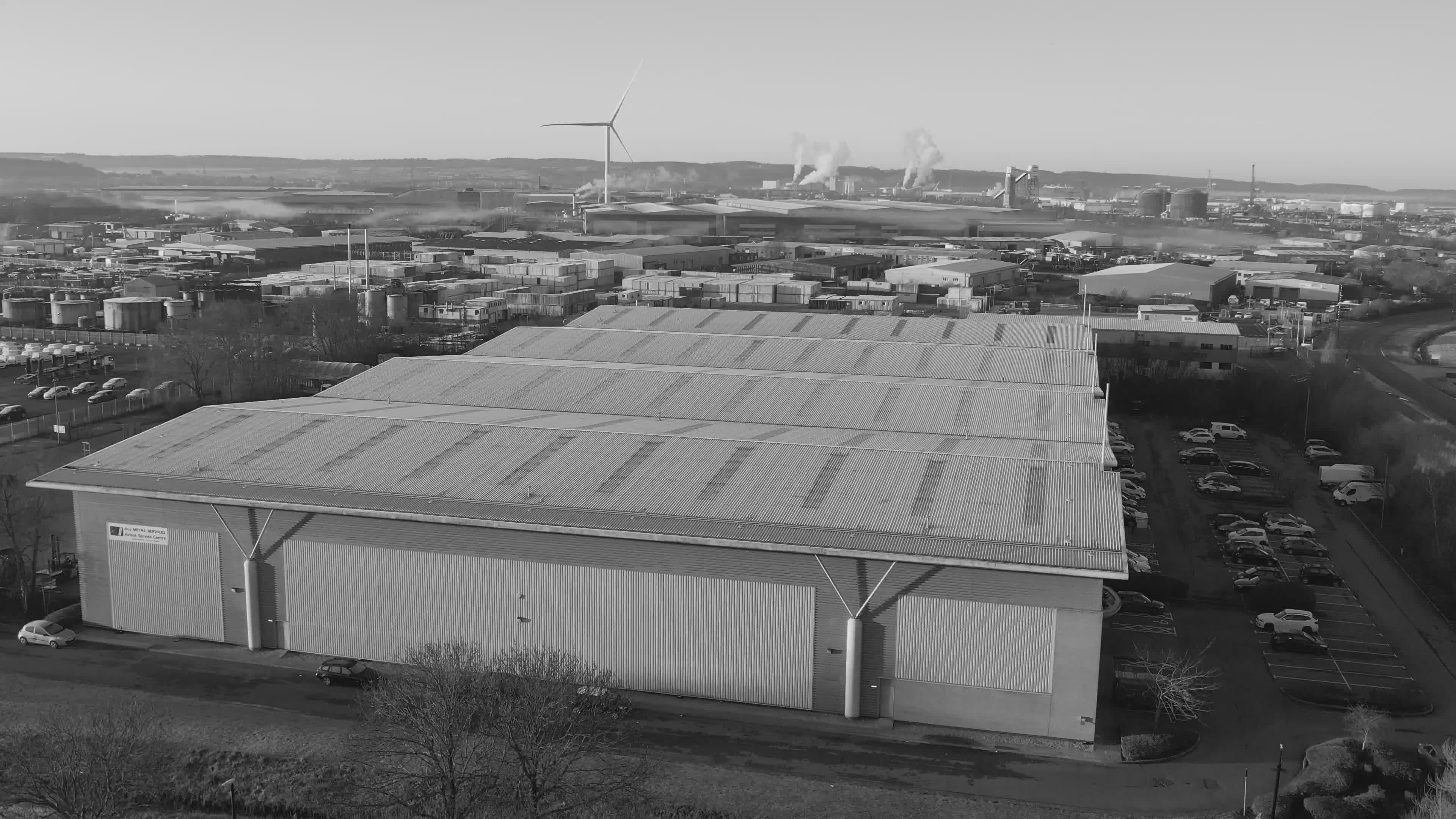Aerial View of Industrial Warehouse with Wind Turbines Free Stock Video ...
