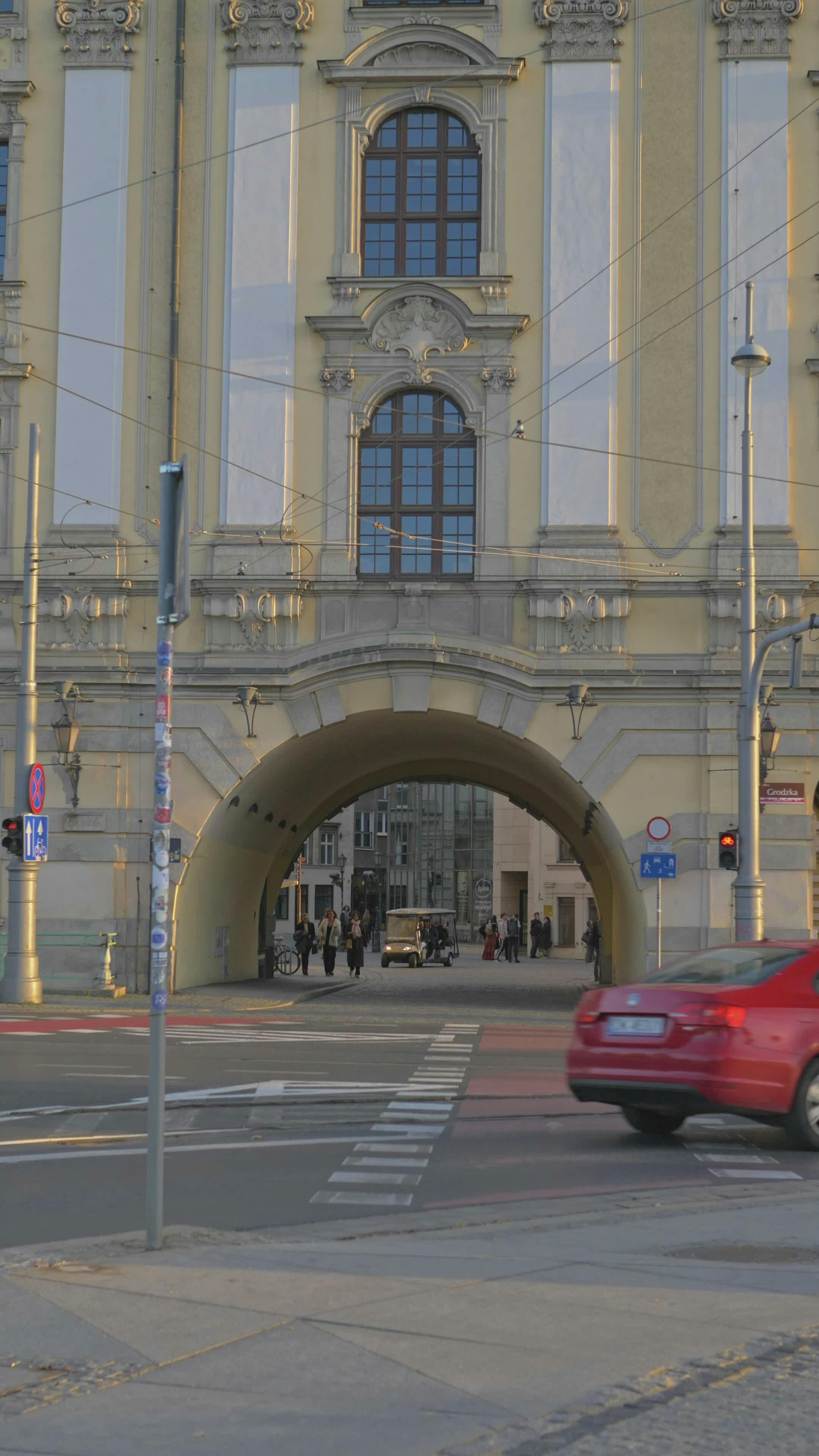 Cyclists Passing Historic Archway in City Free Stock Video Footage ...