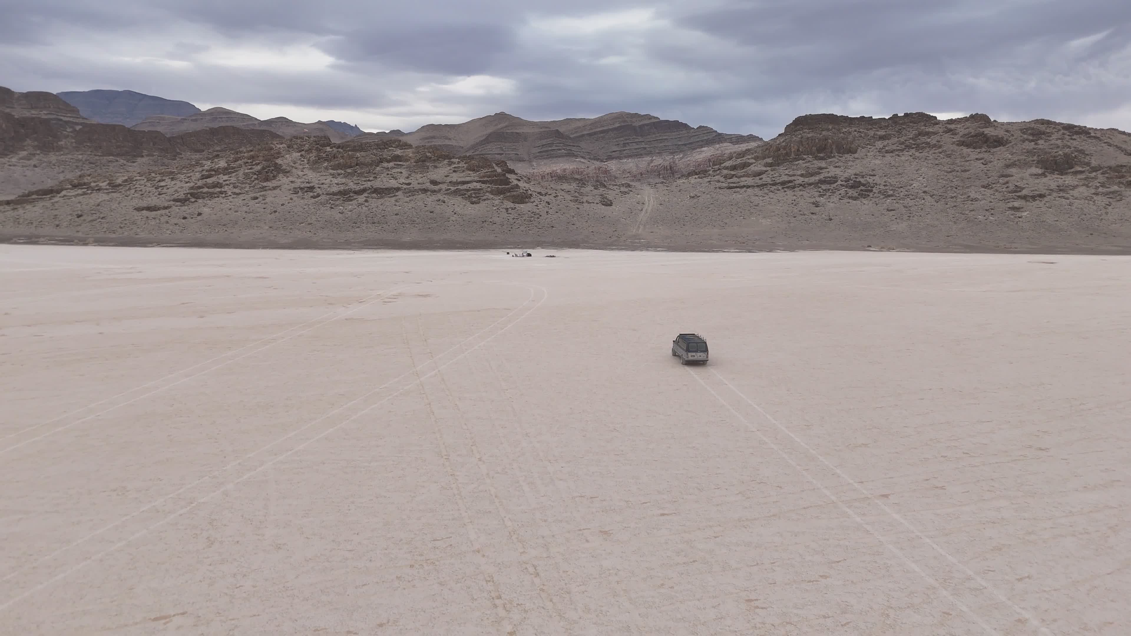 Drone Shot of Car Driving Across Salt Flats Free Stock Video Footage ...