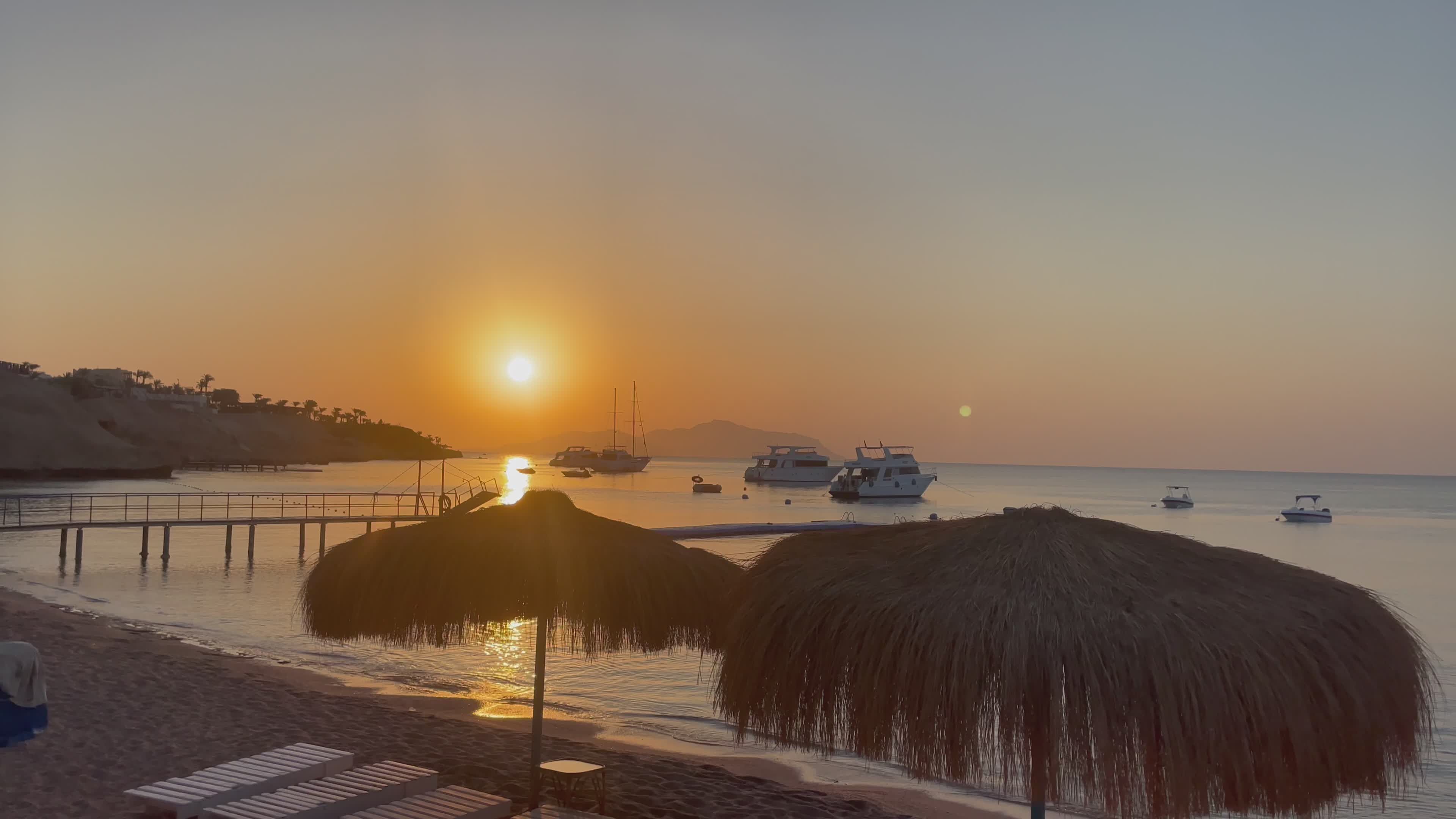 Serene Beachfront Sunset with Boats and Pier Free Stock Video Footage ...