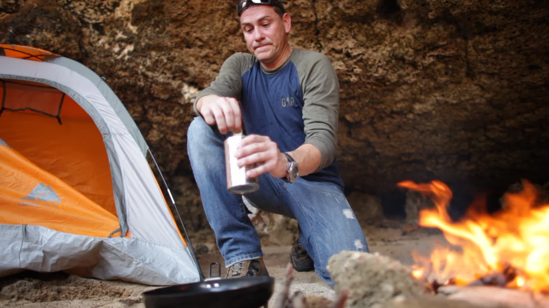 Outdoor Camping Cooking by a Campfire in a Cave Free Stock Video ...