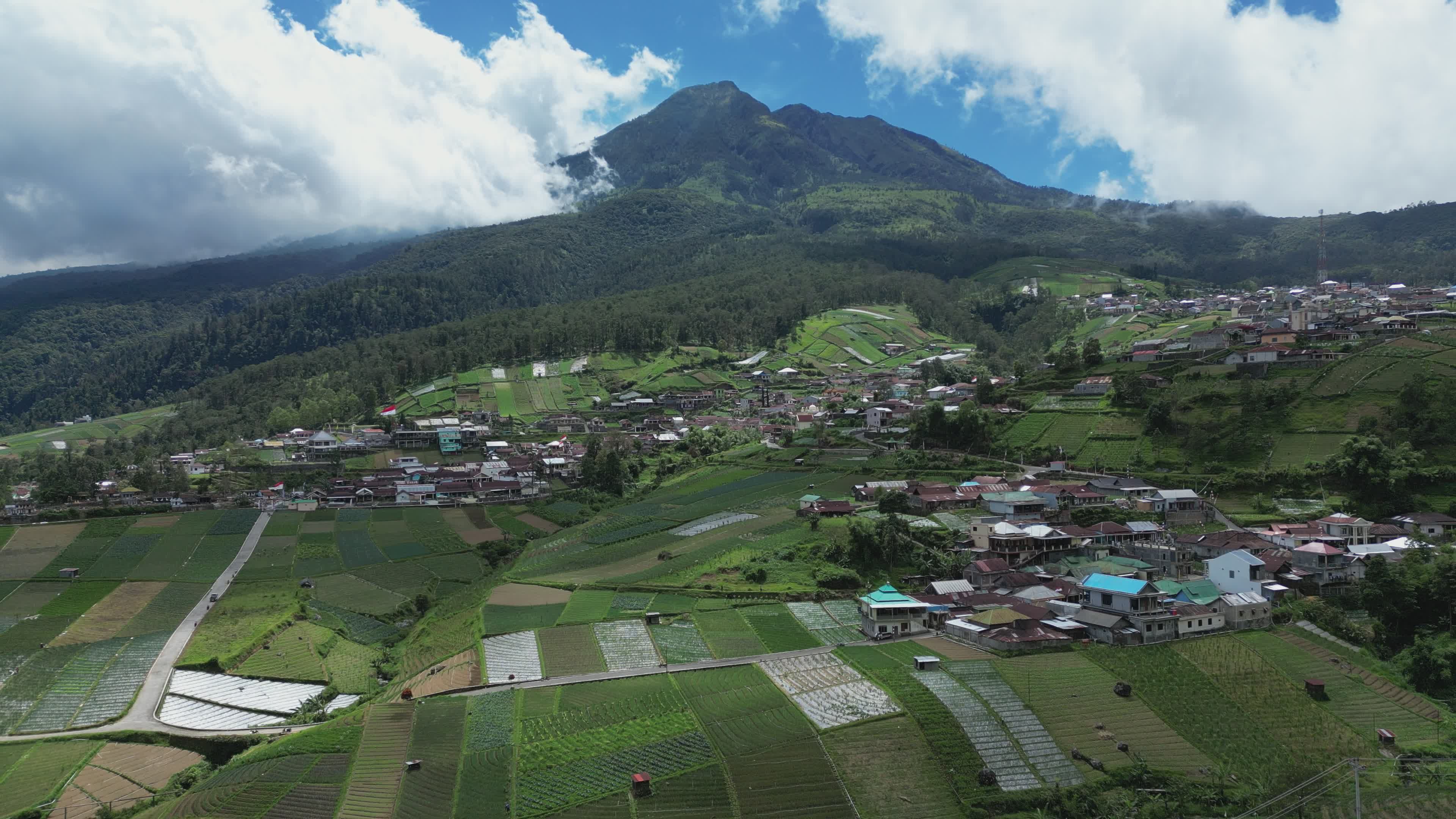 Aerial View of Lush Village with Mountain Backdrop Free Stock Video ...