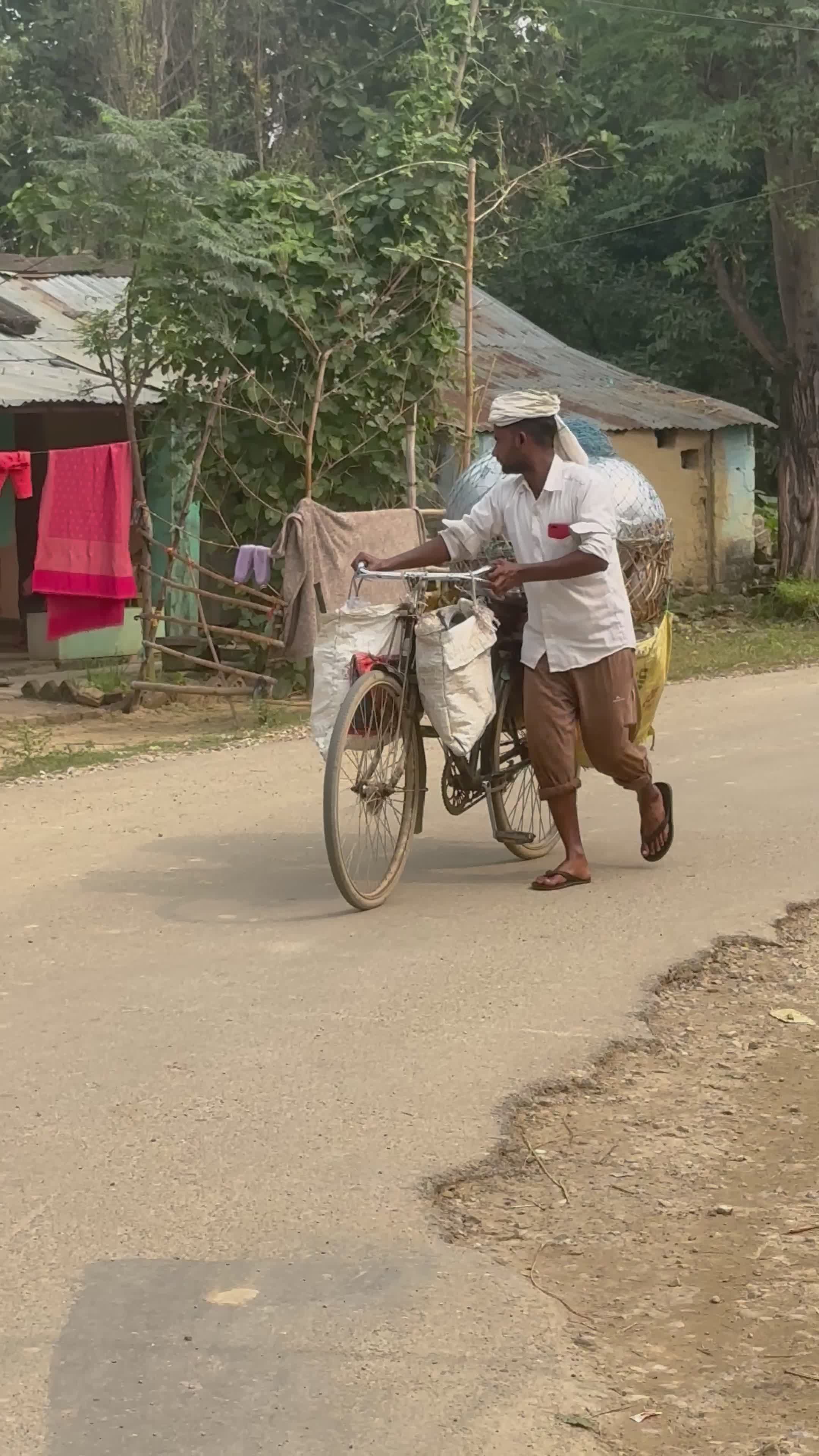 Street Vendor Pushing a Loaded Bicycle in Village Free Stock Video ...