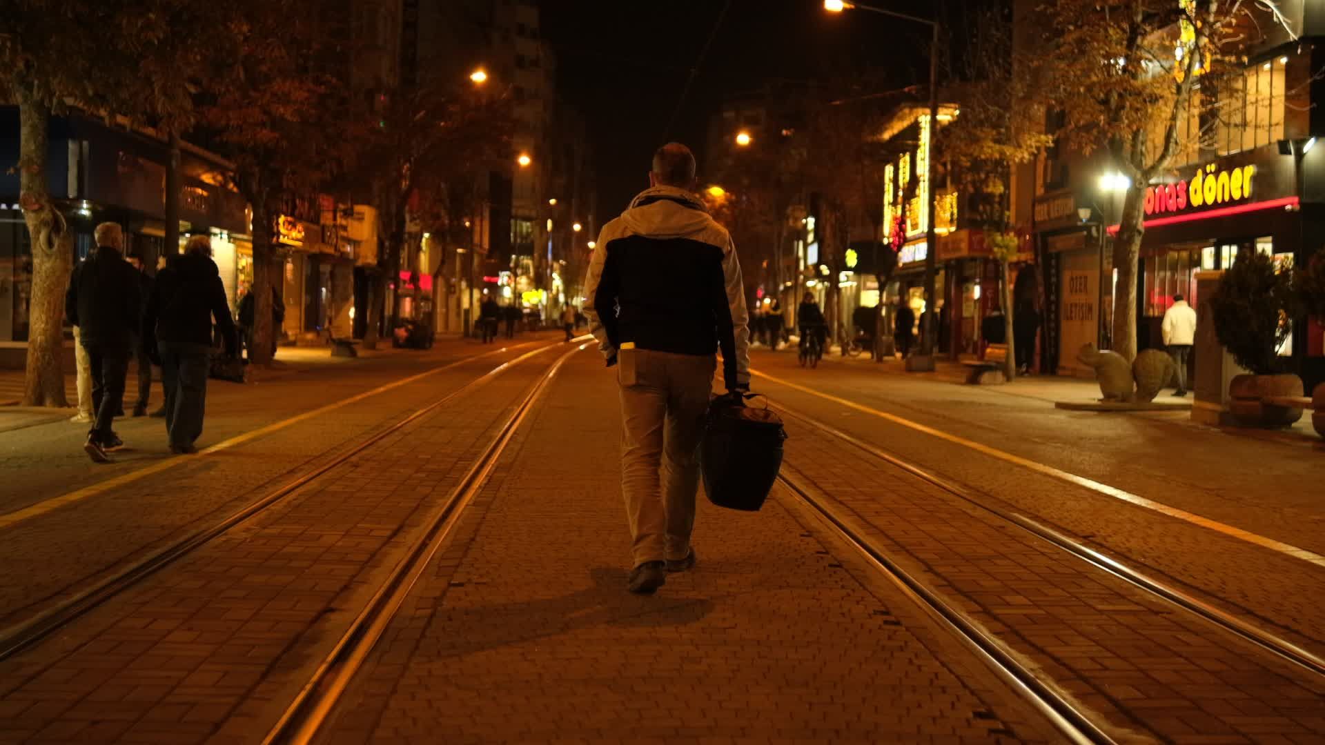 Man Walking on City Street at Night with Tram Free Stock Video Footage ...