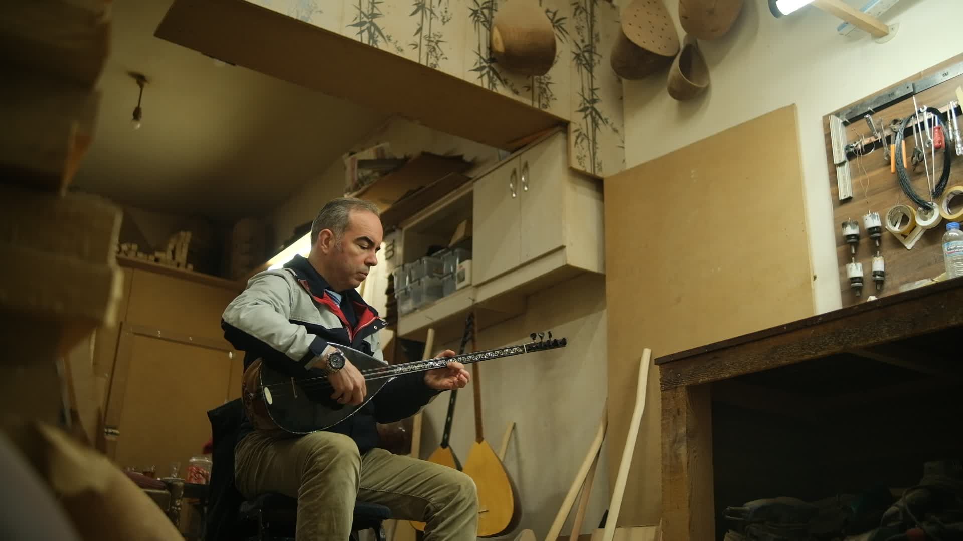 Man Playing Traditional String Instrument In Workshop Free Stock Video ...