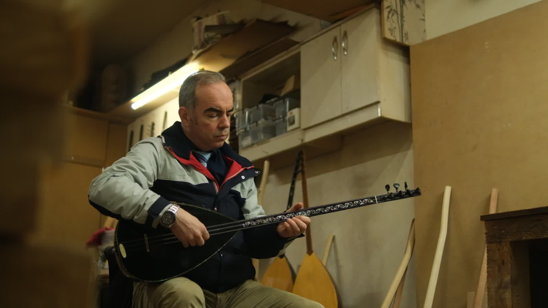 Man Playing Traditional String Instrument in Workshop Free Stock Video ...