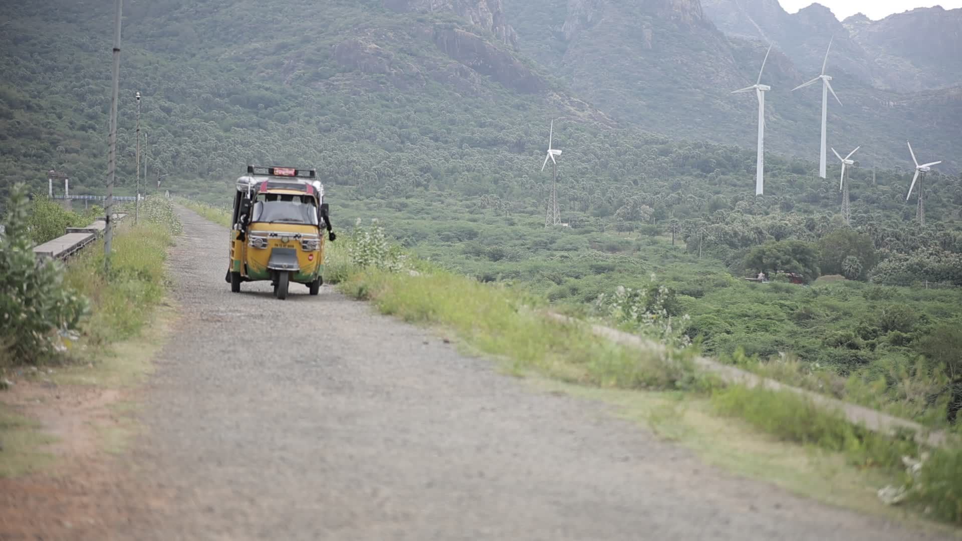 Auto Rickshaw on Scenic Road with Windmills Free Stock Video Footage ...