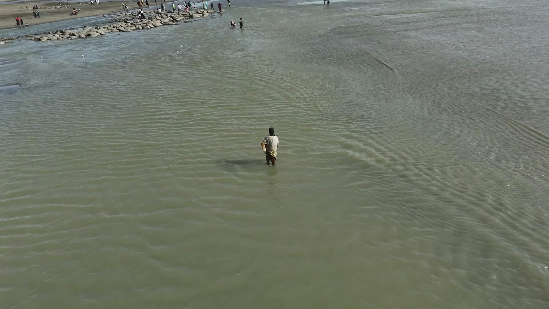 Coastal Fisherman Walking in Shallow Sea Free Stock Video Footage ...