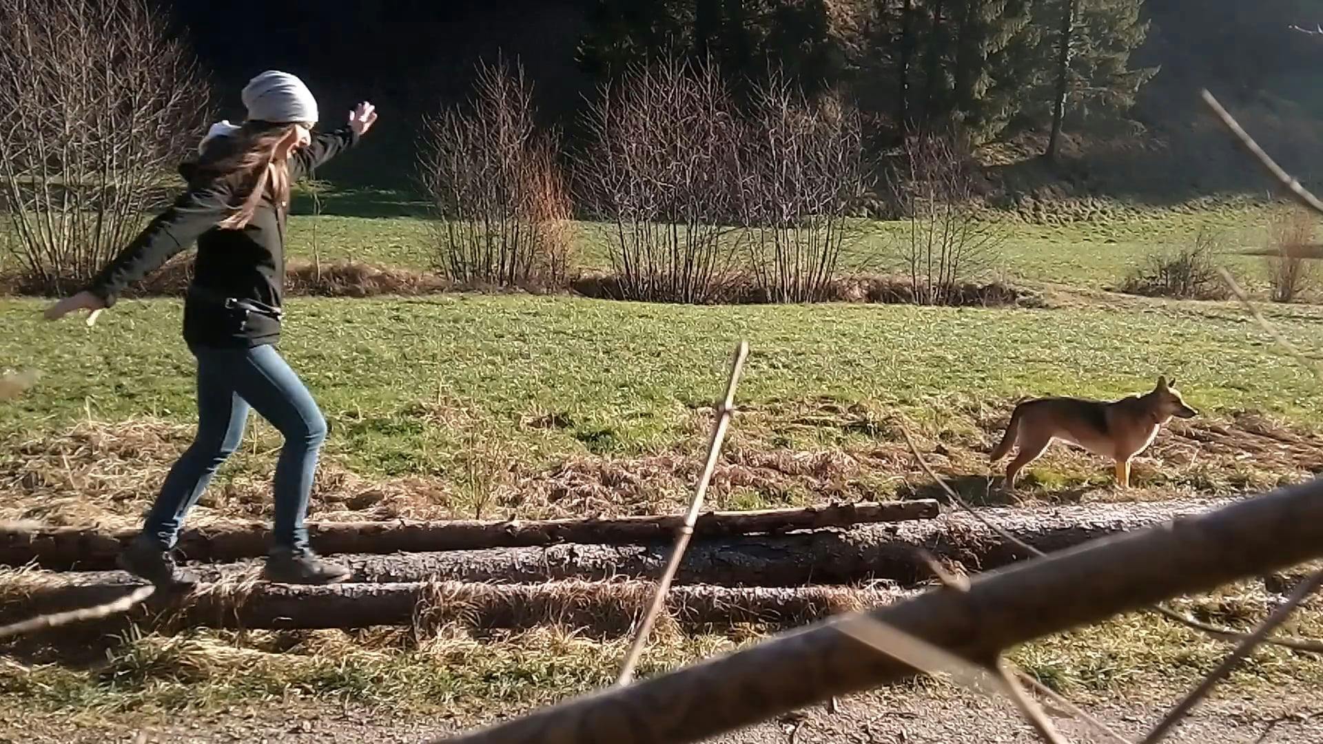A Woman Running Through A Log Lying On The Ground Free Stock Video ...