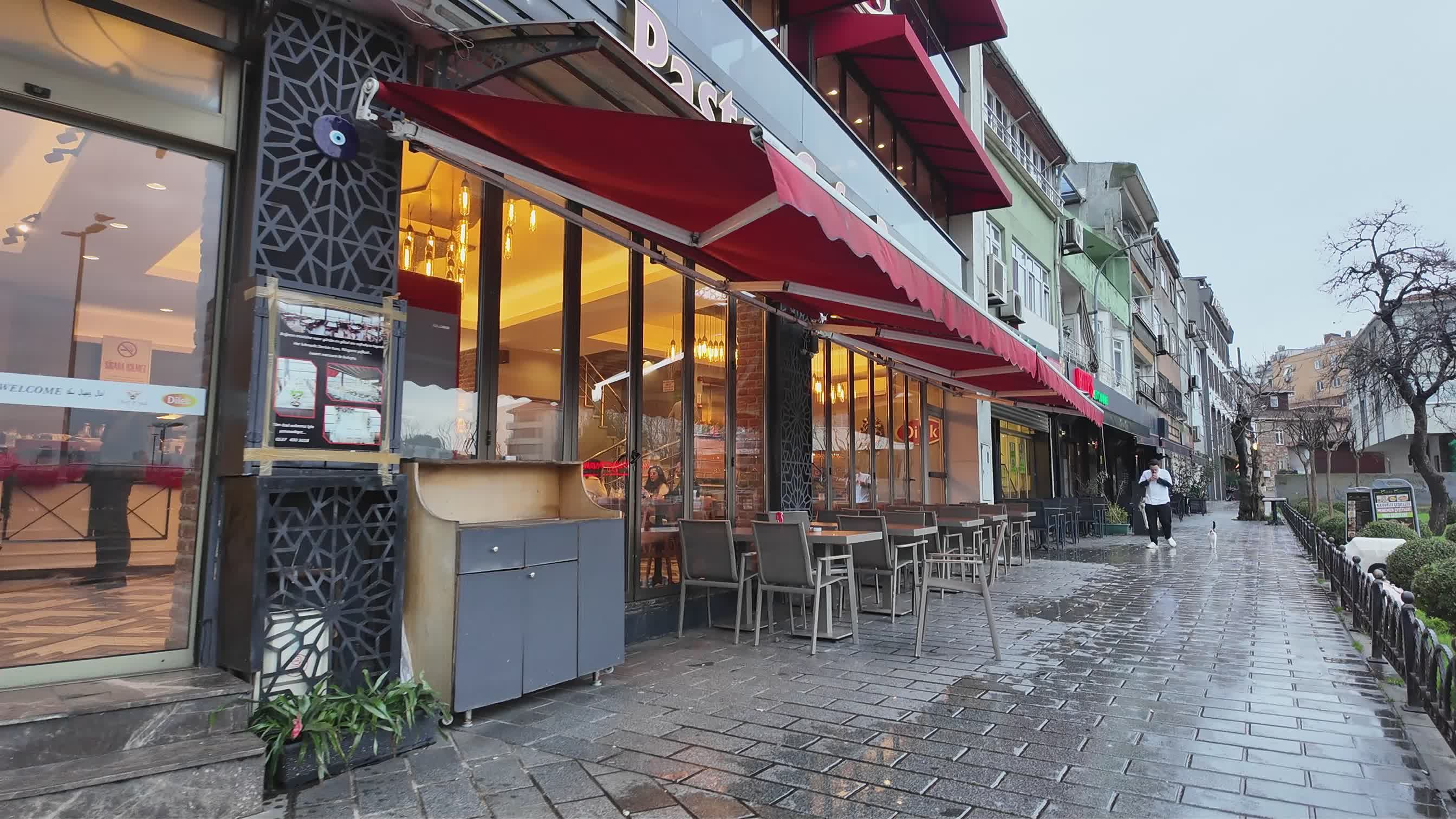 Charming Street Scene with Outdoor Cafes in Rain Free Stock Video ...